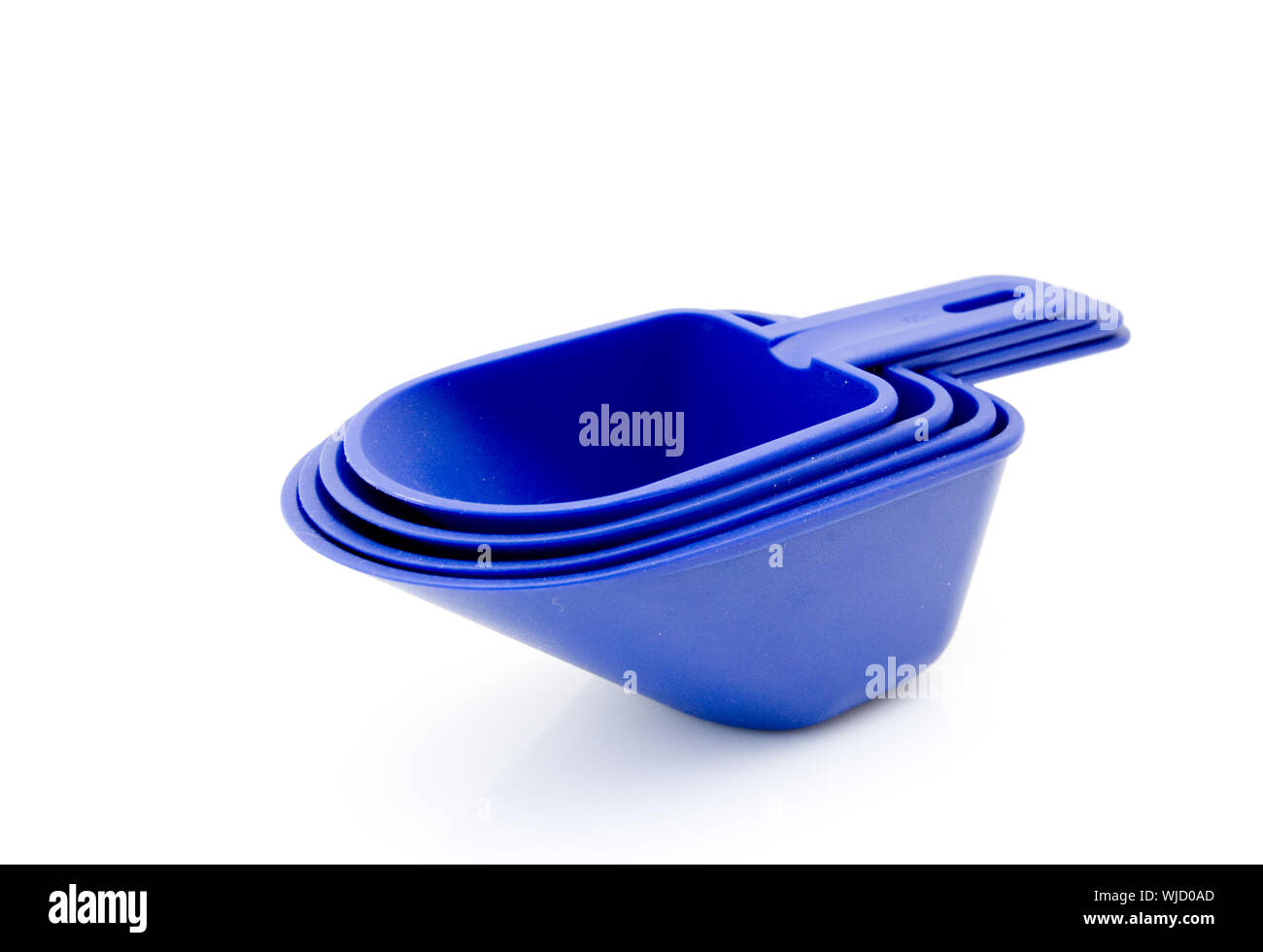 Stack of blue platic measuring cups on white Stock Photo - Alamy