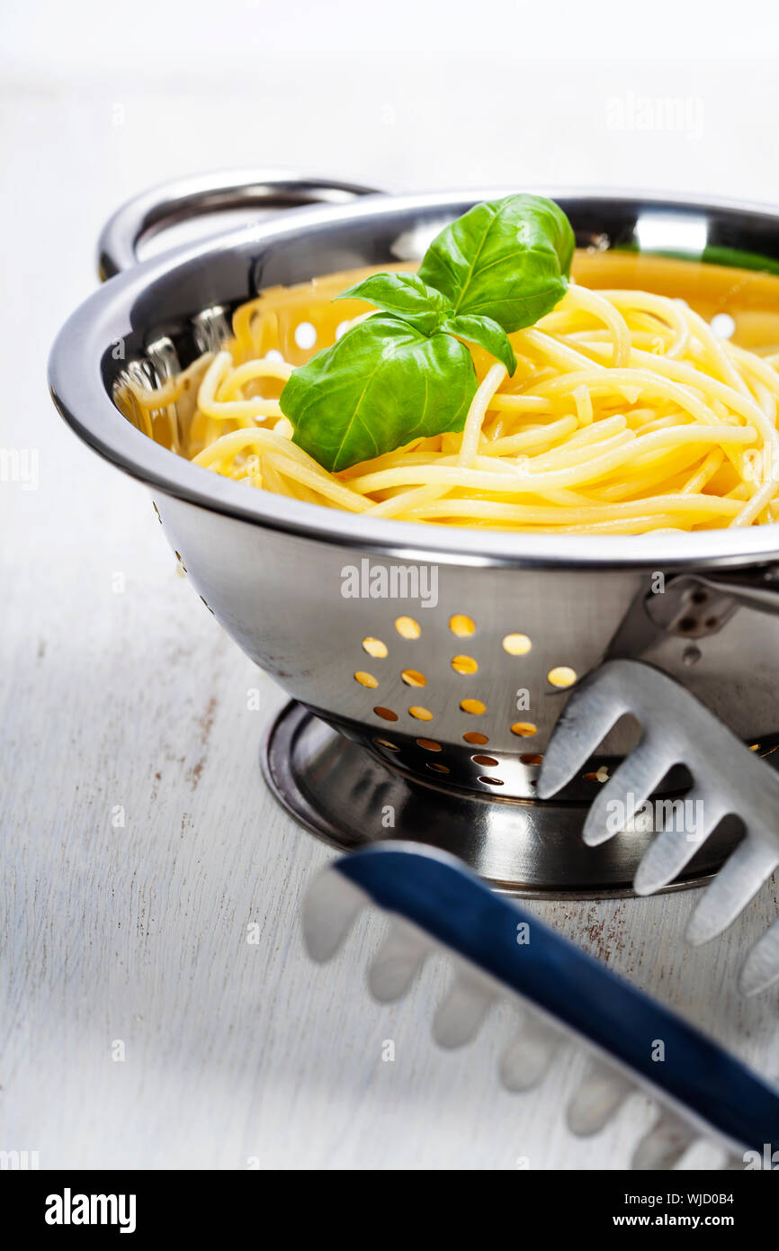 spaghetti in colander over white Stock Photo - Alamy
