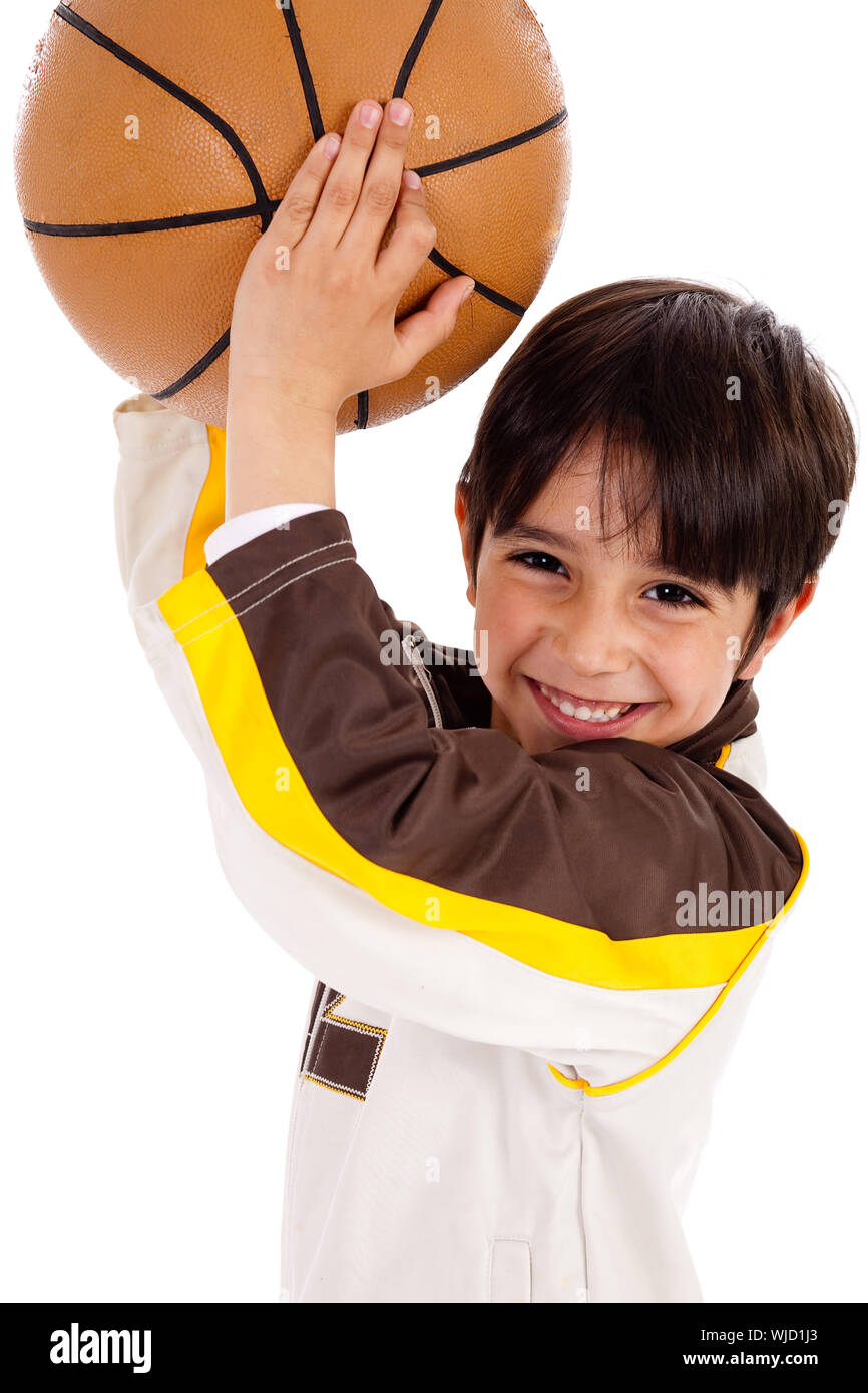 Little kid while throwing the ball while playing the basket ball on ...