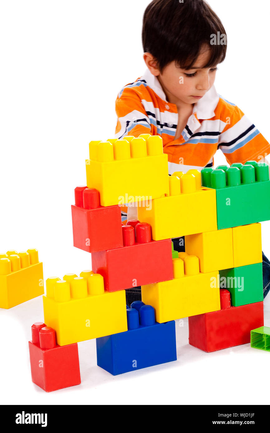 Young boy playing with building blocks on white background Stock Photo ...