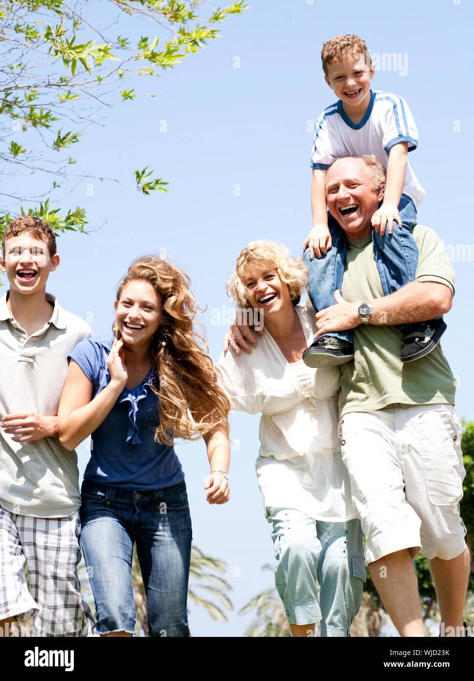 Happy family having fun in the park with three children Stock Photo - Alamy