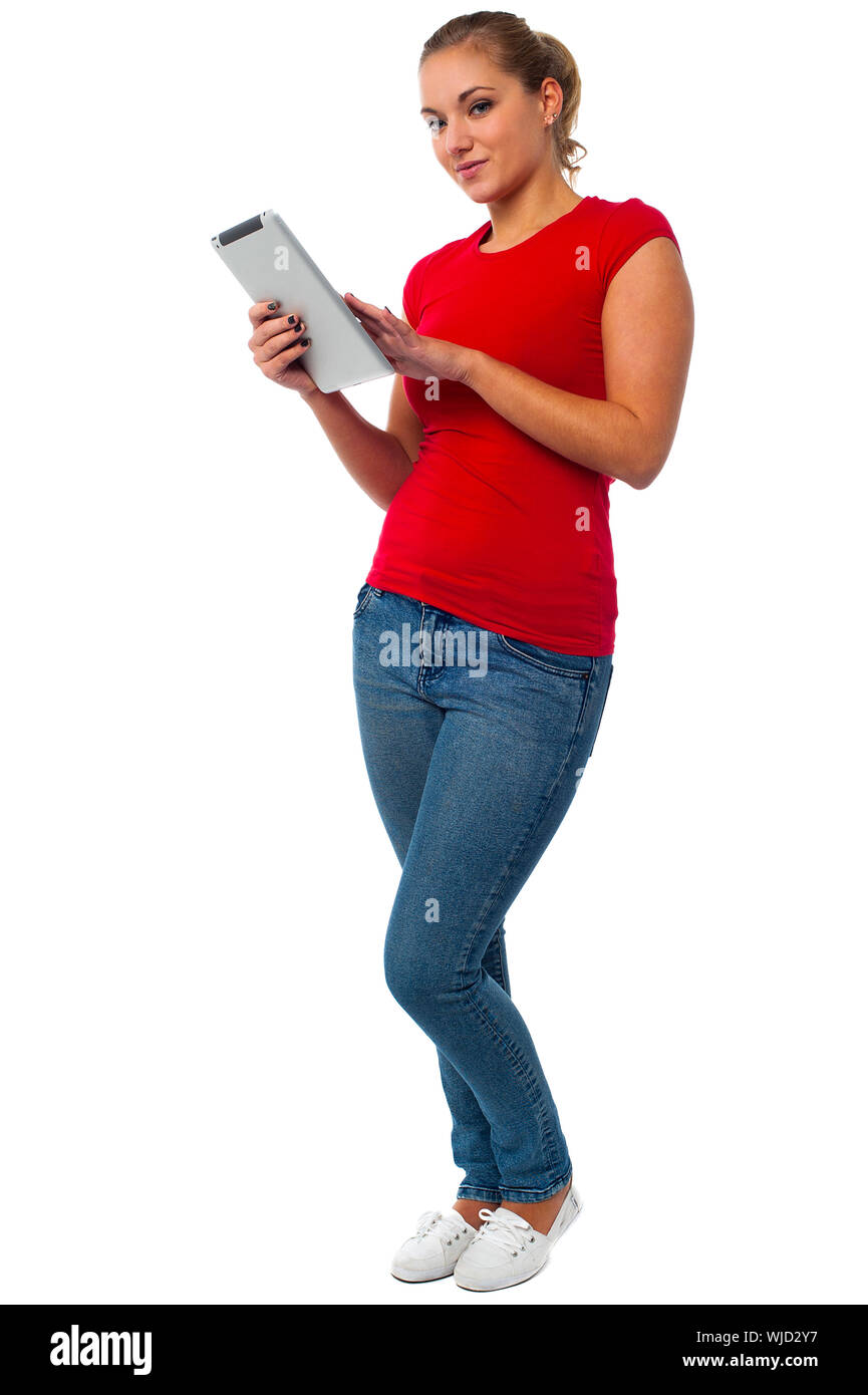 Fashionable young female operating her tablet pc Stock Photo - Alamy