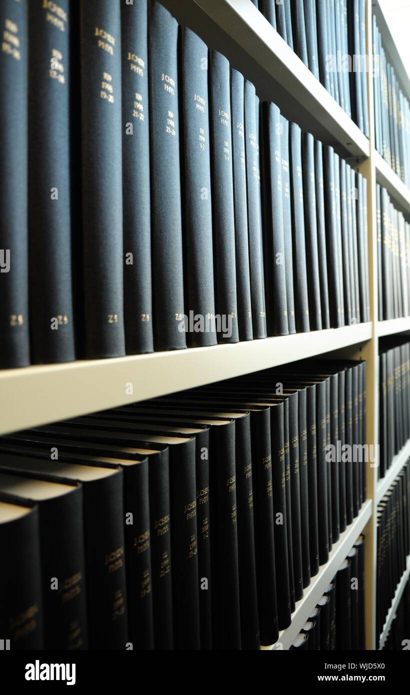 old books in a library bookshelf showing education concept Stock Photo ...
