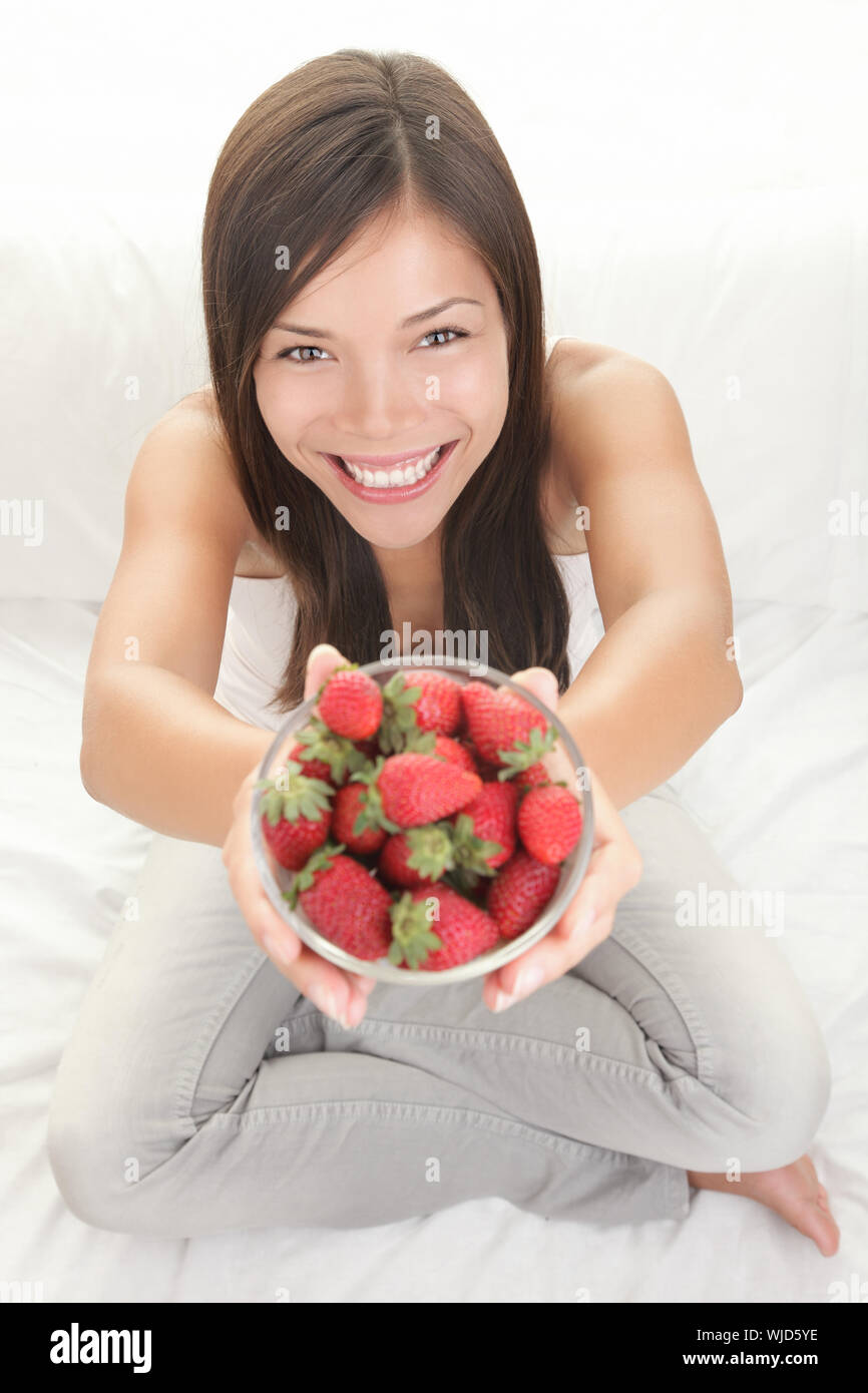 Strawberry woman showing fresh strawberries. Top view of beautiful ...