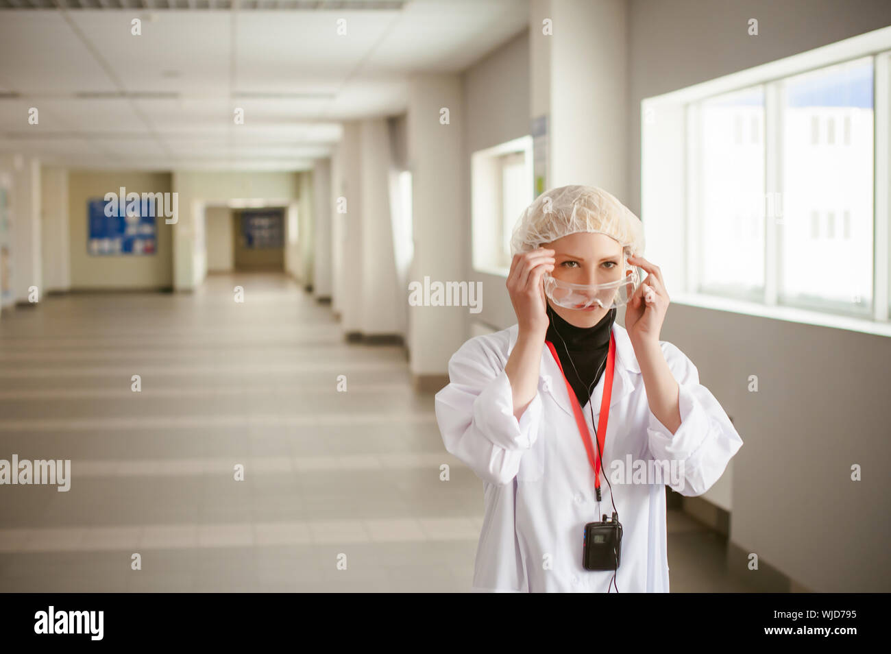 Female doctor standing in hospital corridor hi-res stock photography ...