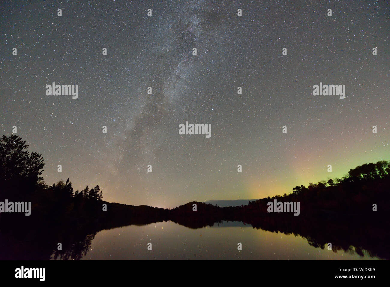 The Milky Way, with a faint Aurora (northern lights) reflected in St ...