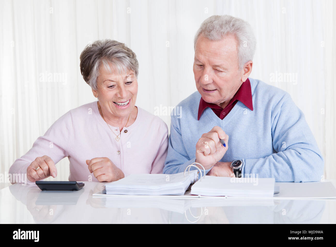 Photo of Senior Couple Calculating Budget At Home Stock Photo - Alamy