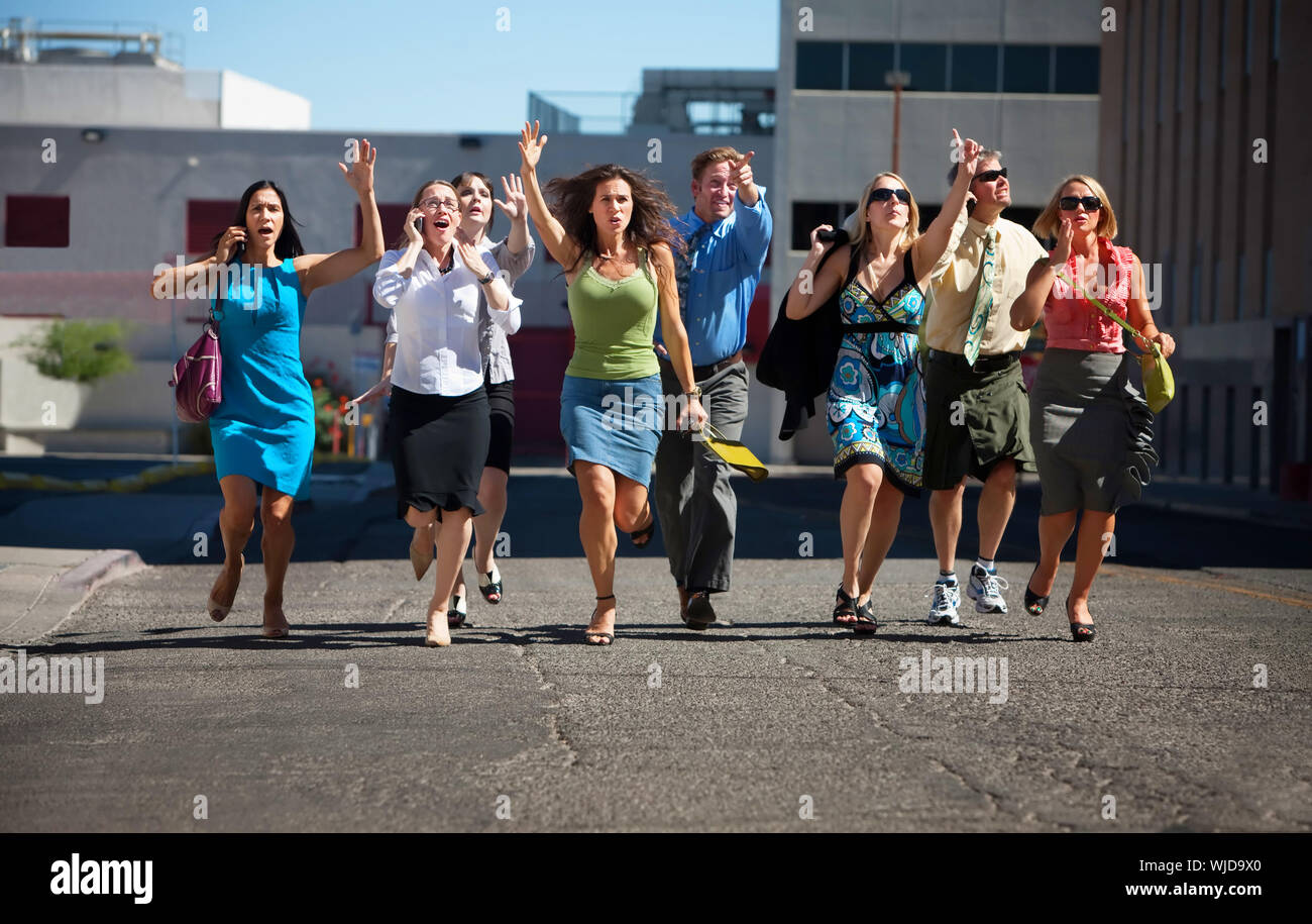 Group of hard working business men and women run down city street Stock ...