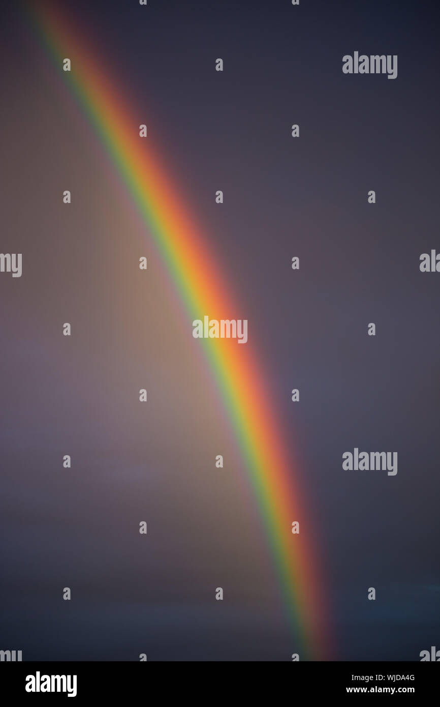 Curved Rainbow On A Blue Sky Background Stock Photo - Alamy