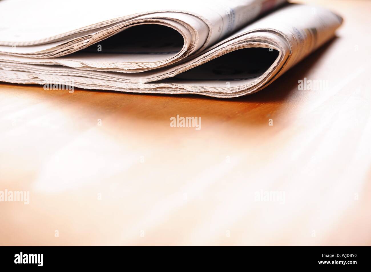 stack of newspaper on desktop showing news concept Stock Photo - Alamy