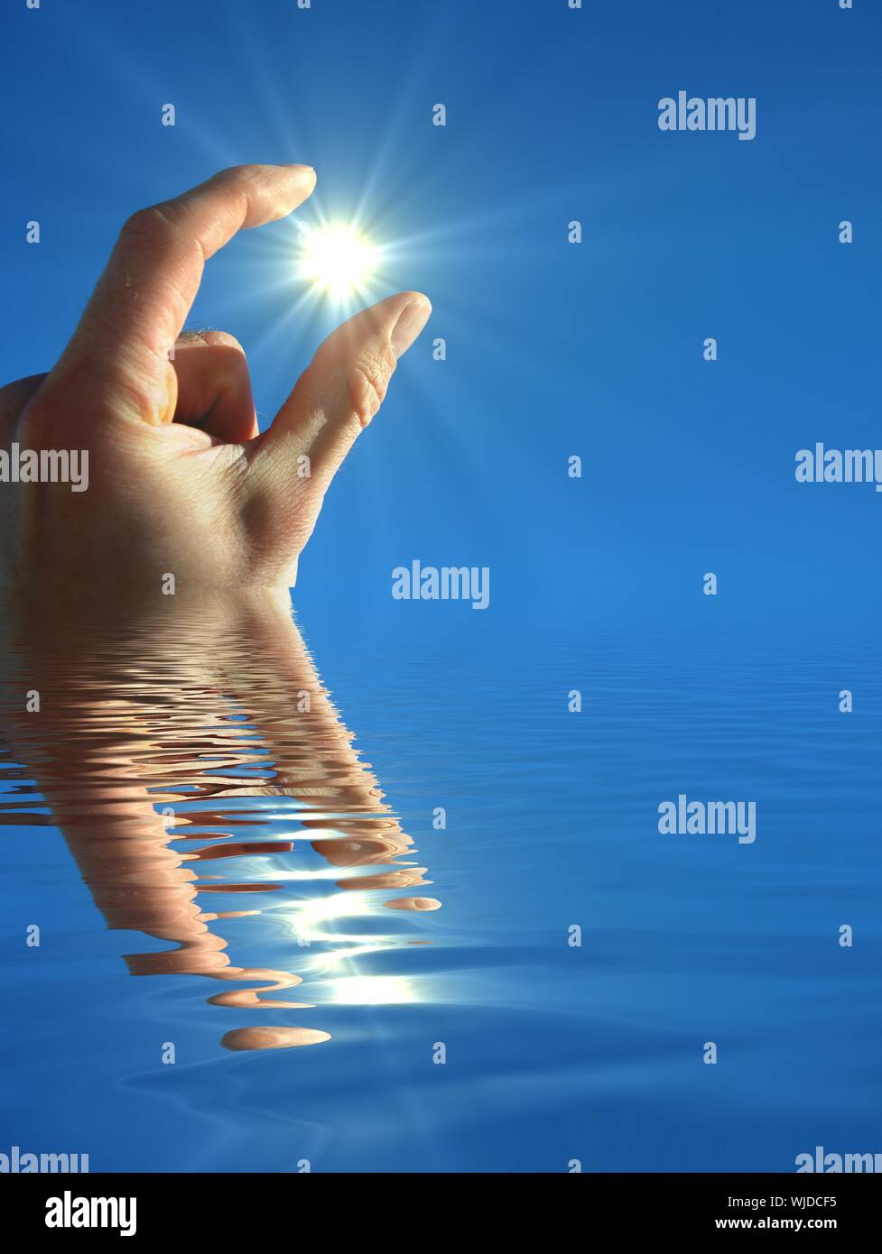 hand holding sun and water reflaction with copyspace Stock Photo - Alamy