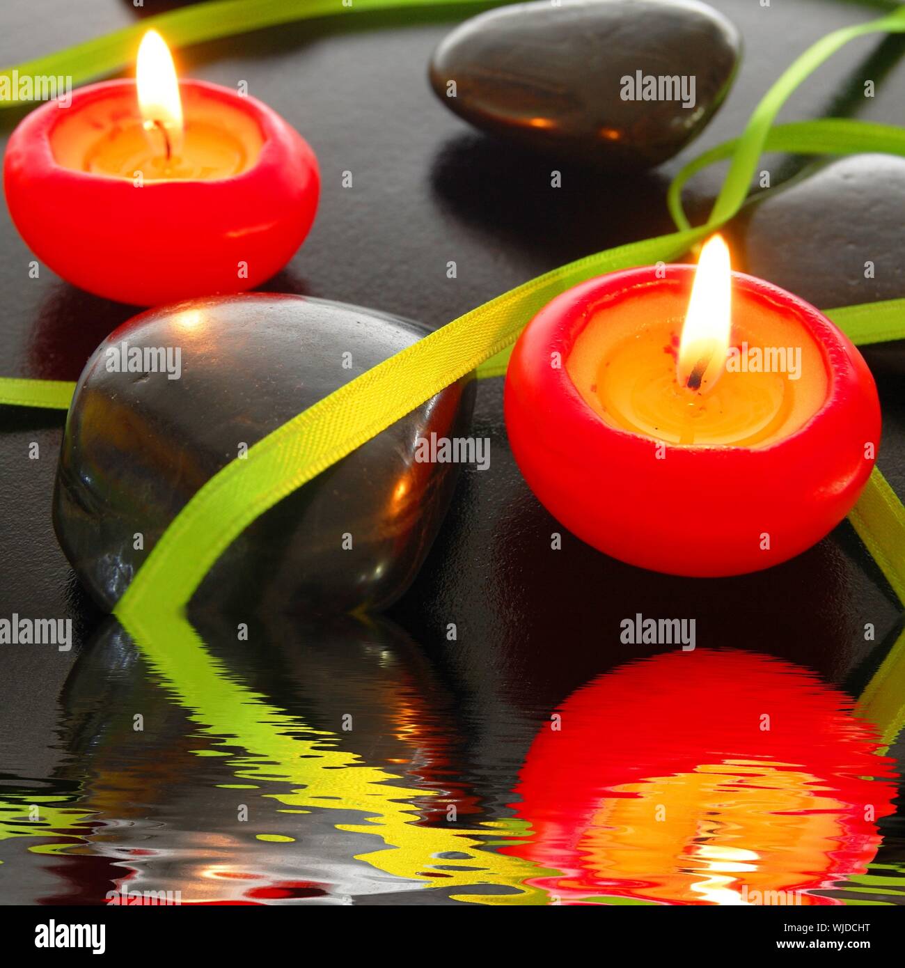 spa candle and water reflection showing zen concept Stock Photo - Alamy