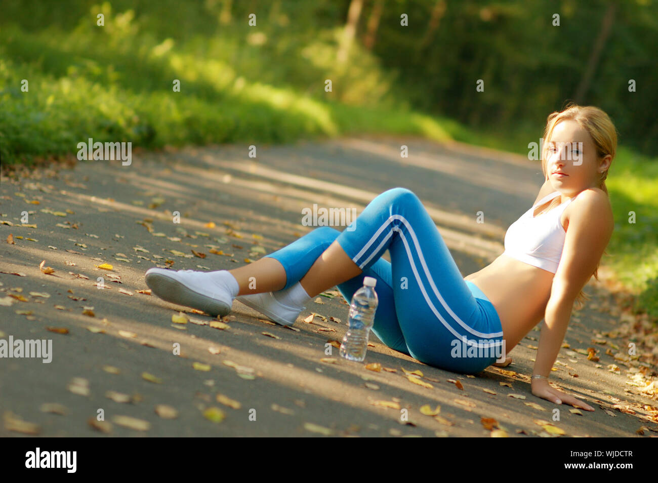 Pretty young girl runner in the forest Stock Photo - Alamy