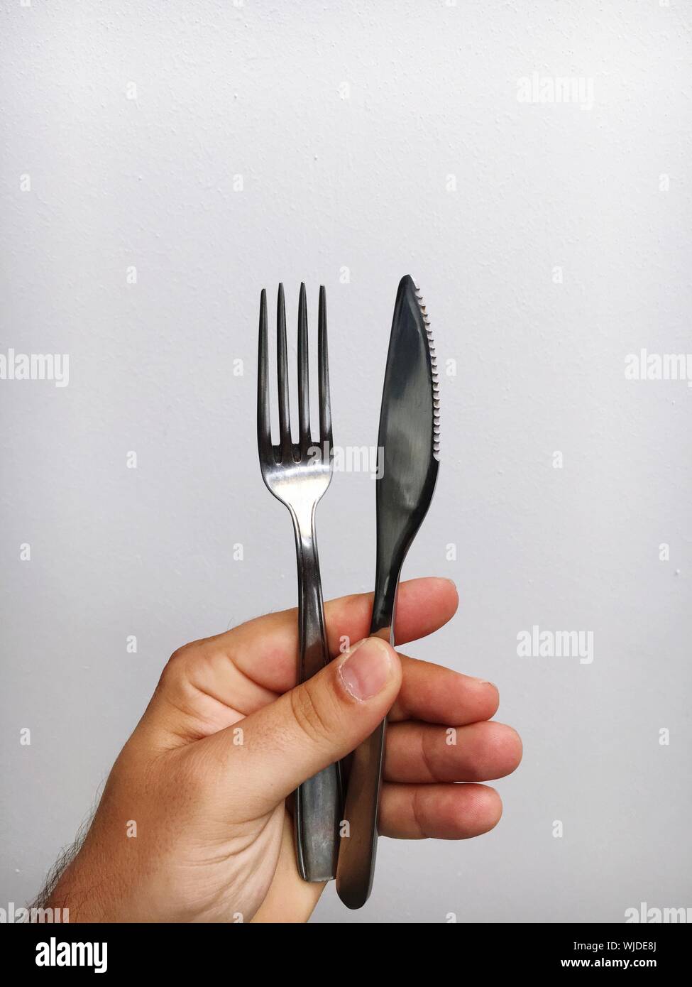 Man holding knife and fork High Resolution Stock Photography and Images ...