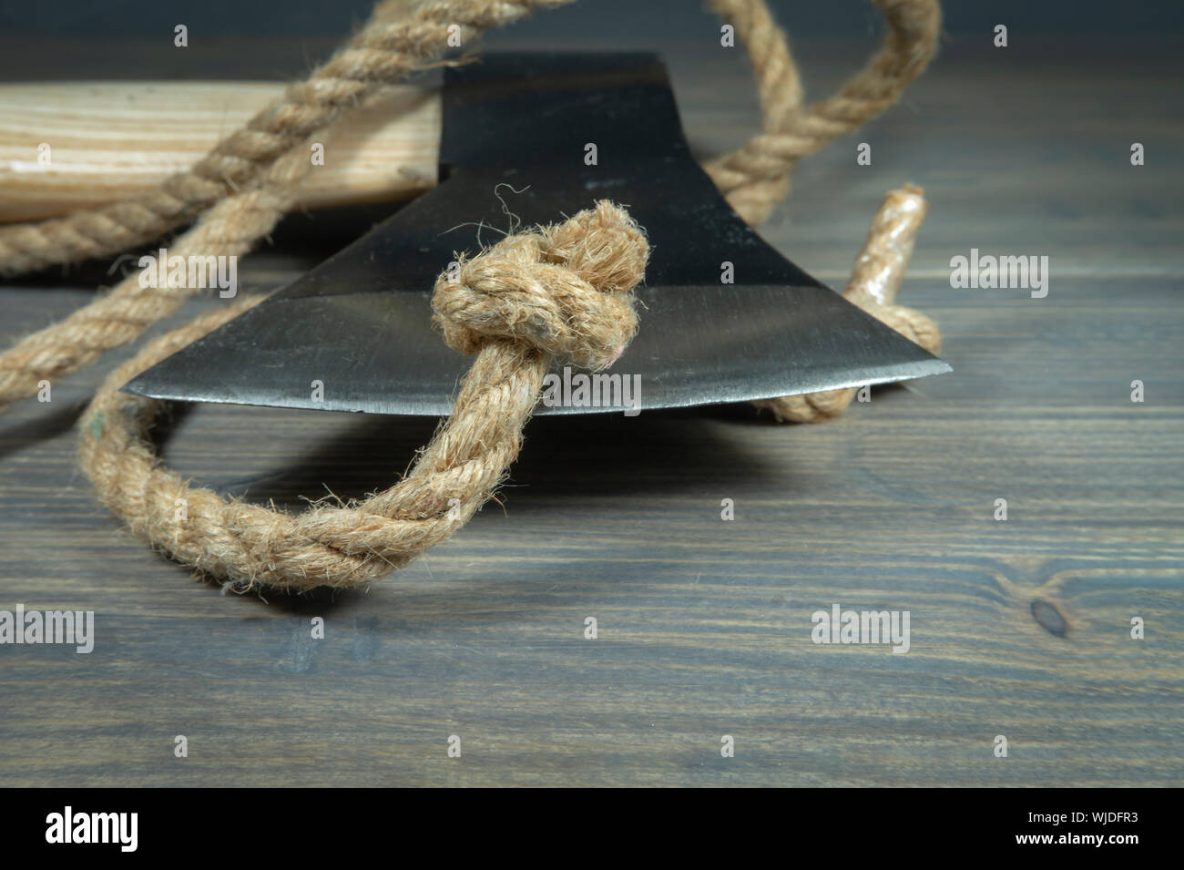 Metal axe or hatchet tool cutting natural jute rope. To cut the Gordian ...