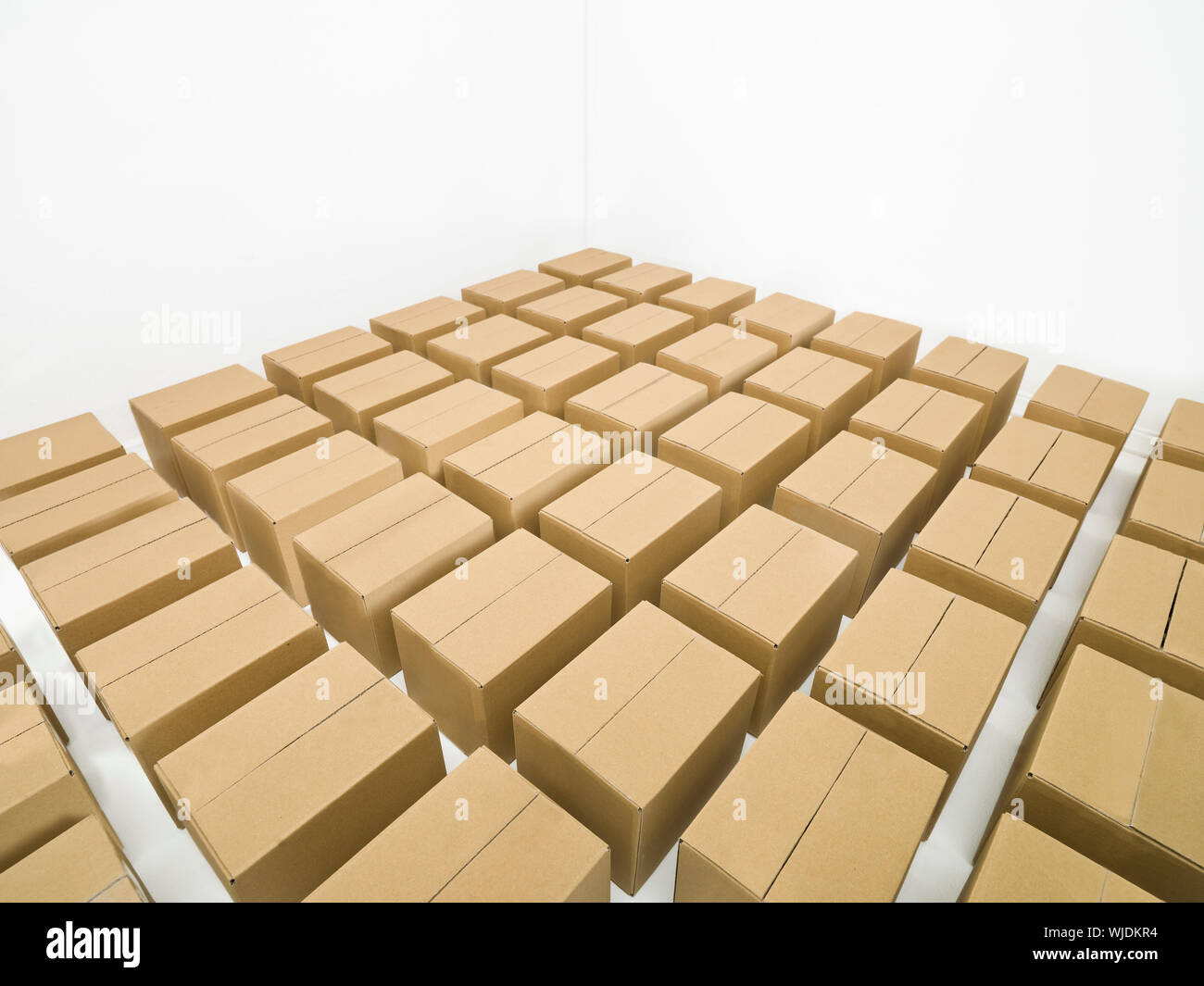 Arranged cardboard boxes on white background Stock Photo - Alamy