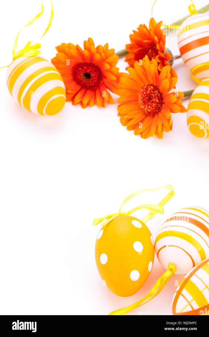 Colourful yellow hand decorated traditional Easter eggs with stripes and polka dot patterns ...