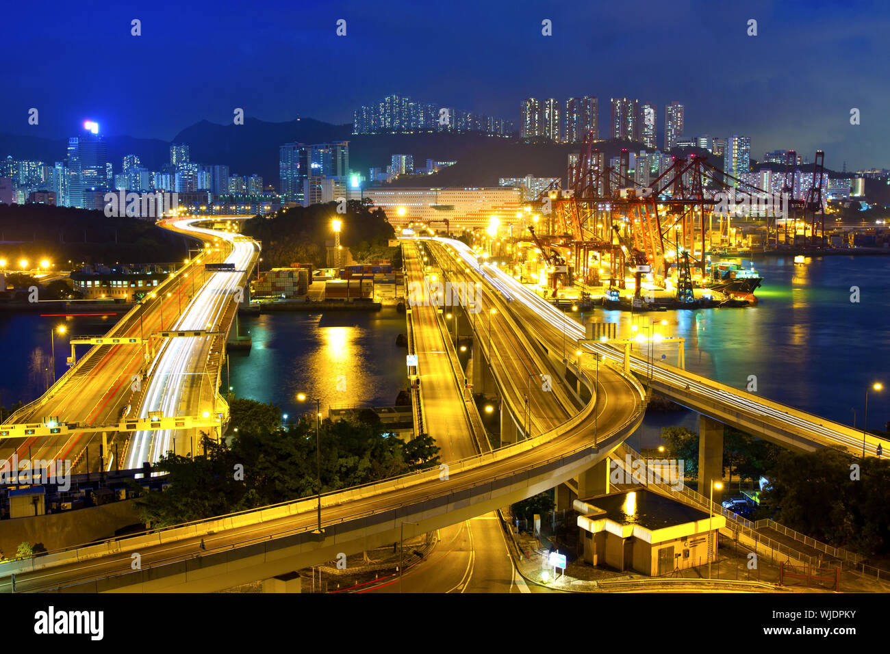 Cargo terminal traffic in city at night Stock Photo - Alamy