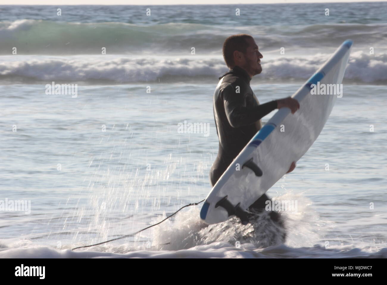 Man carrying surfboard hi-res stock photography and images - Alamy
