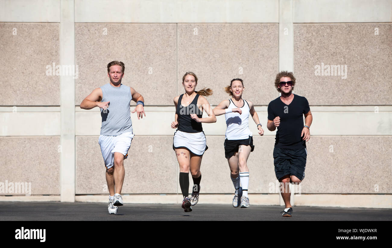 Two couples running for fun Stock Photo - Alamy