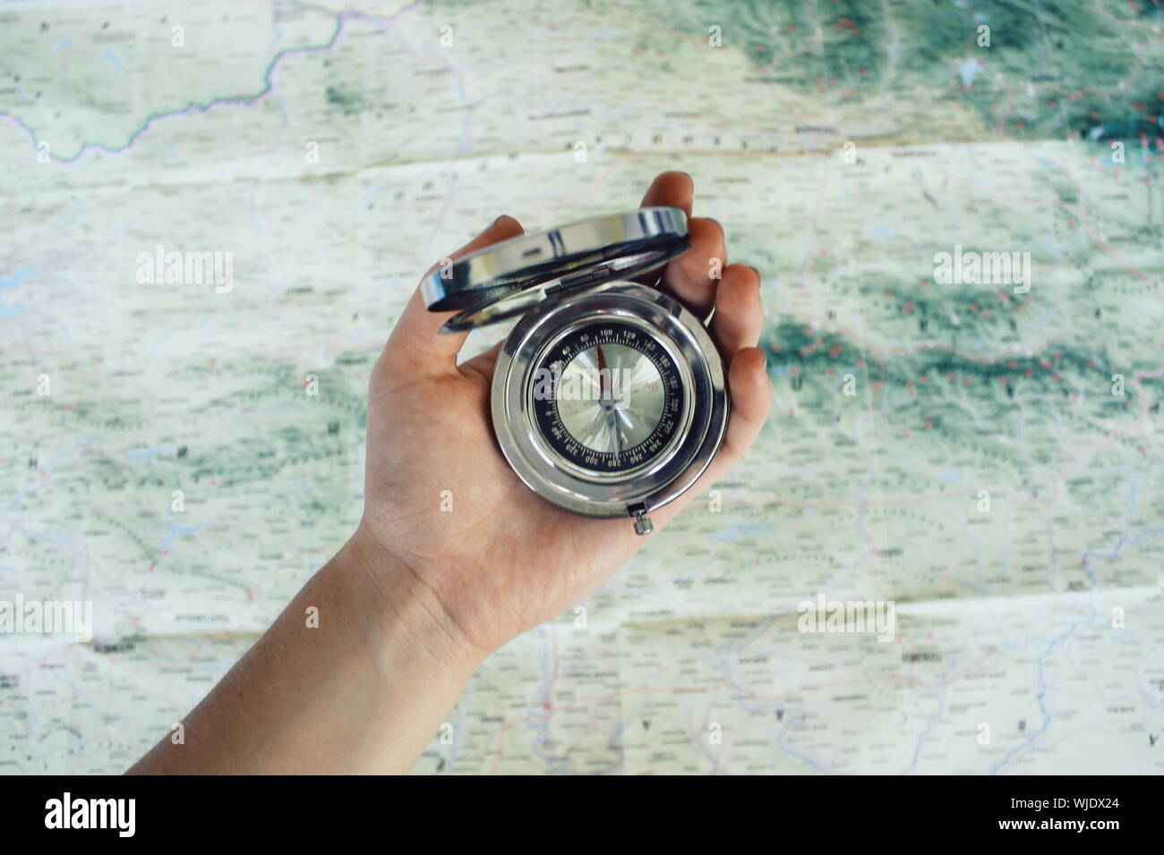 Holding map compass hi-res stock photography and images - Alamy