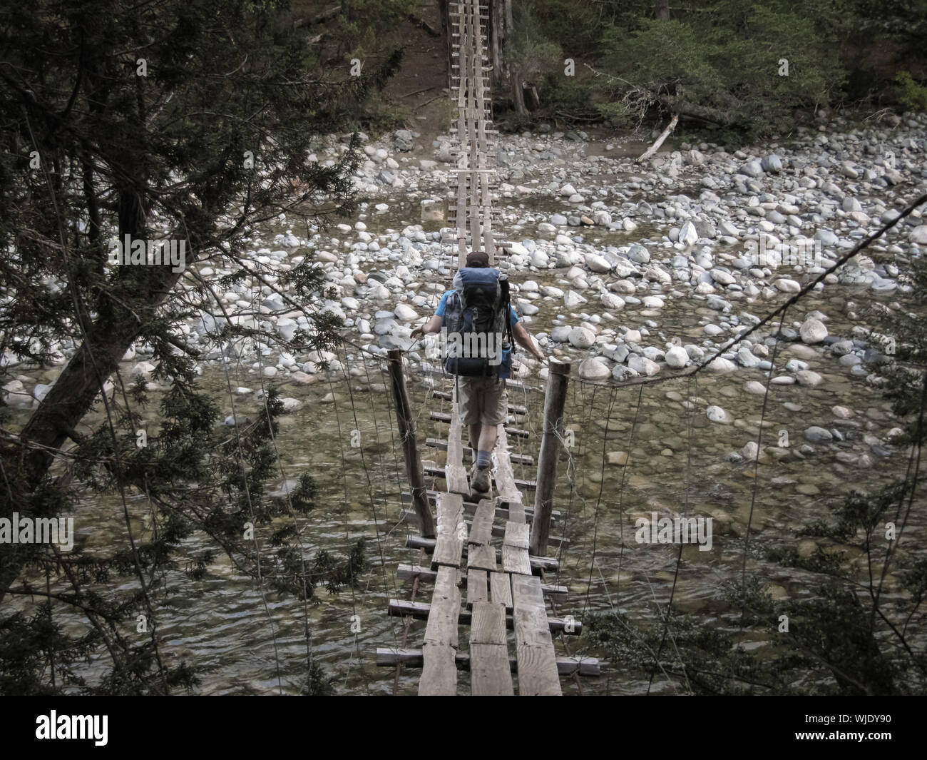 Man walking over footbridge hi-res stock photography and images - Alamy