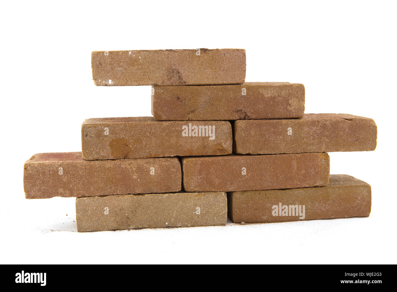 Building a wall with many bricks isolated over white Stock Photo - Alamy