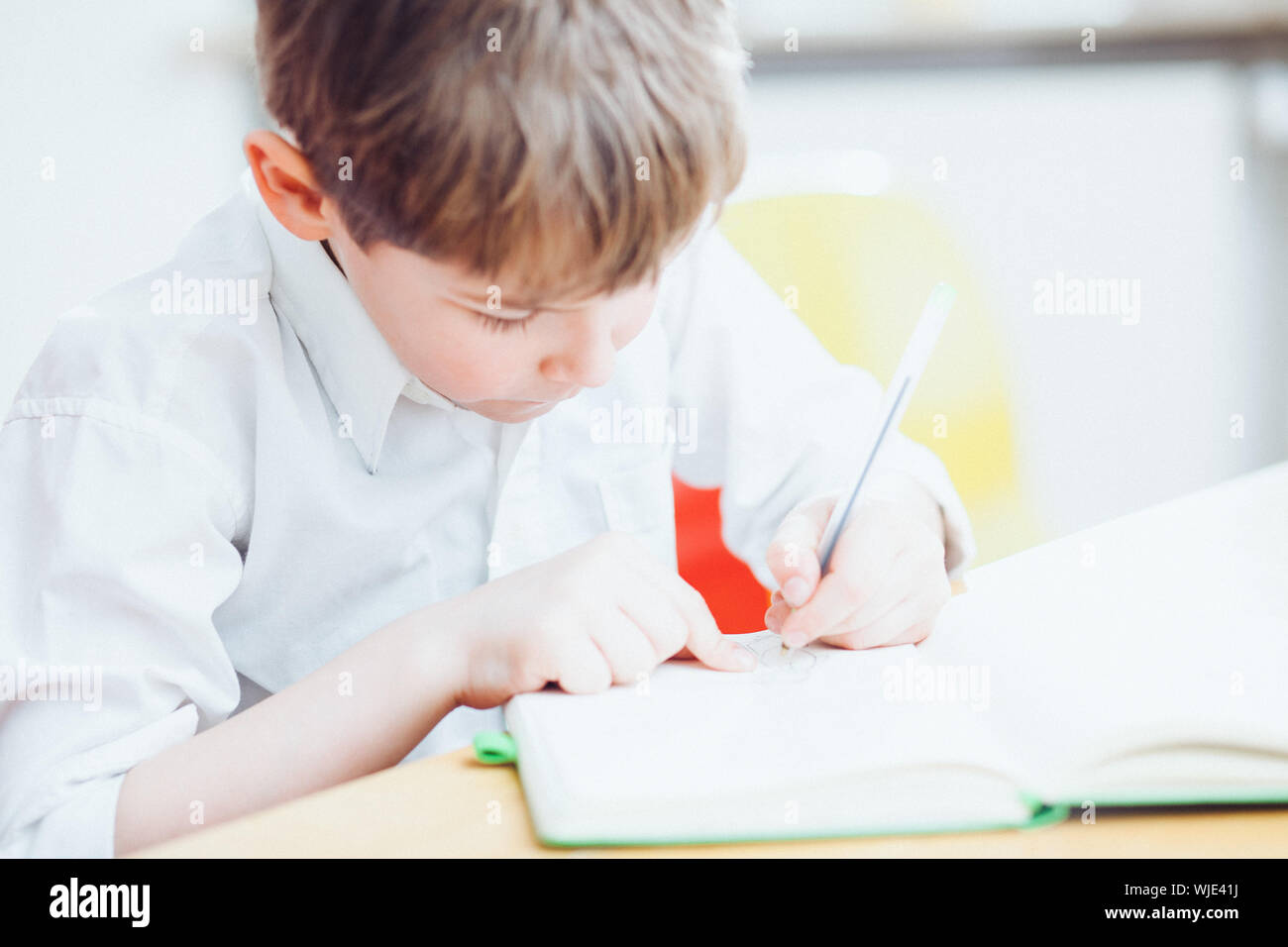 Boy Writing At Table High Resolution Stock Photography and Images - Alamy