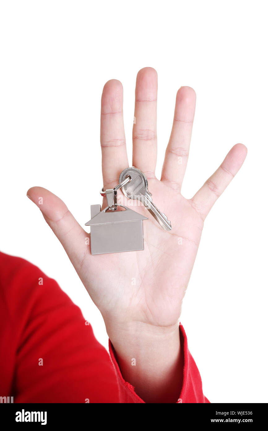 Hand holding a house key. Isolated on white background Stock Photo - Alamy