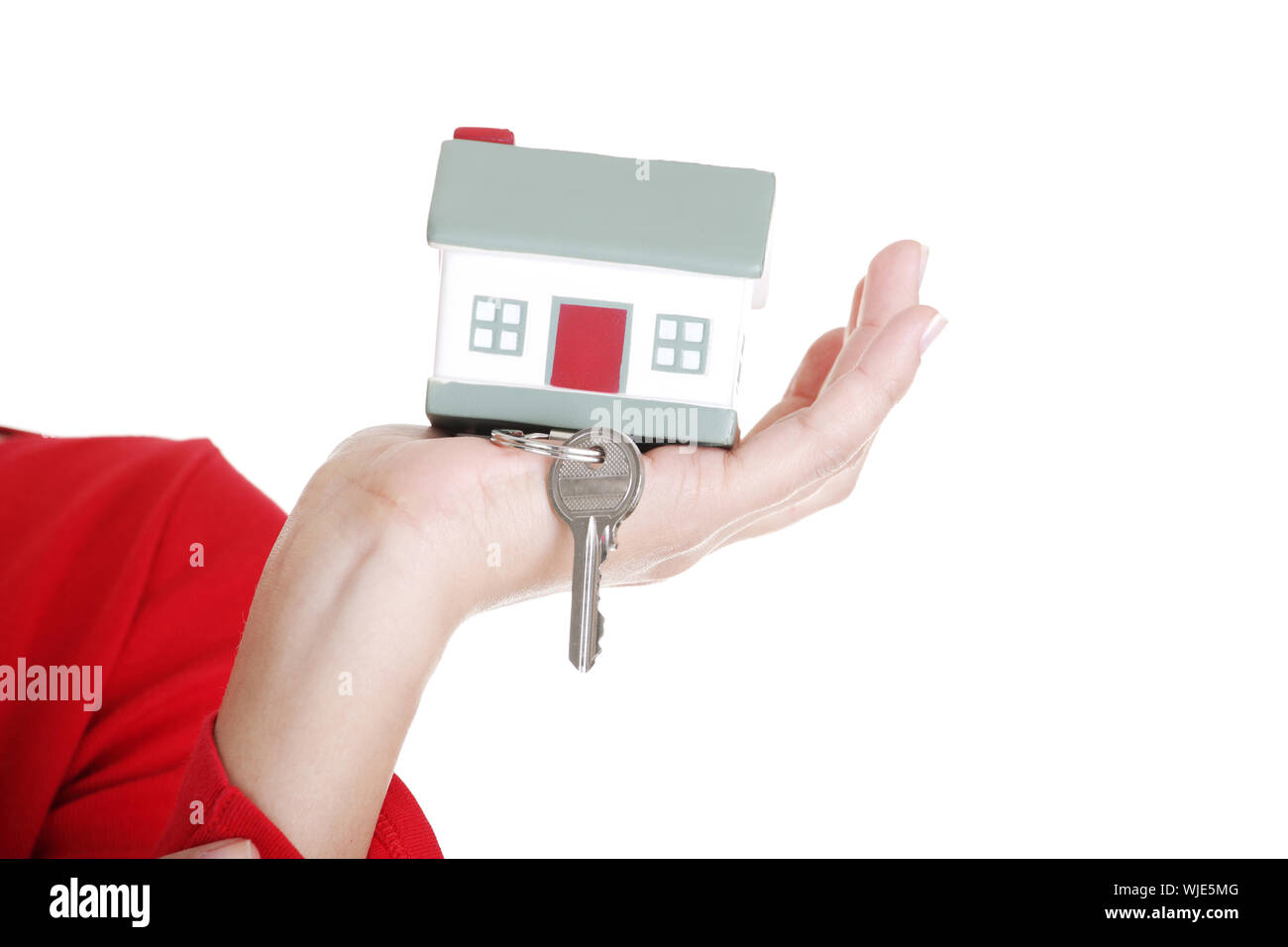 Hand holding a house key. Isolated on white background Stock Photo - Alamy