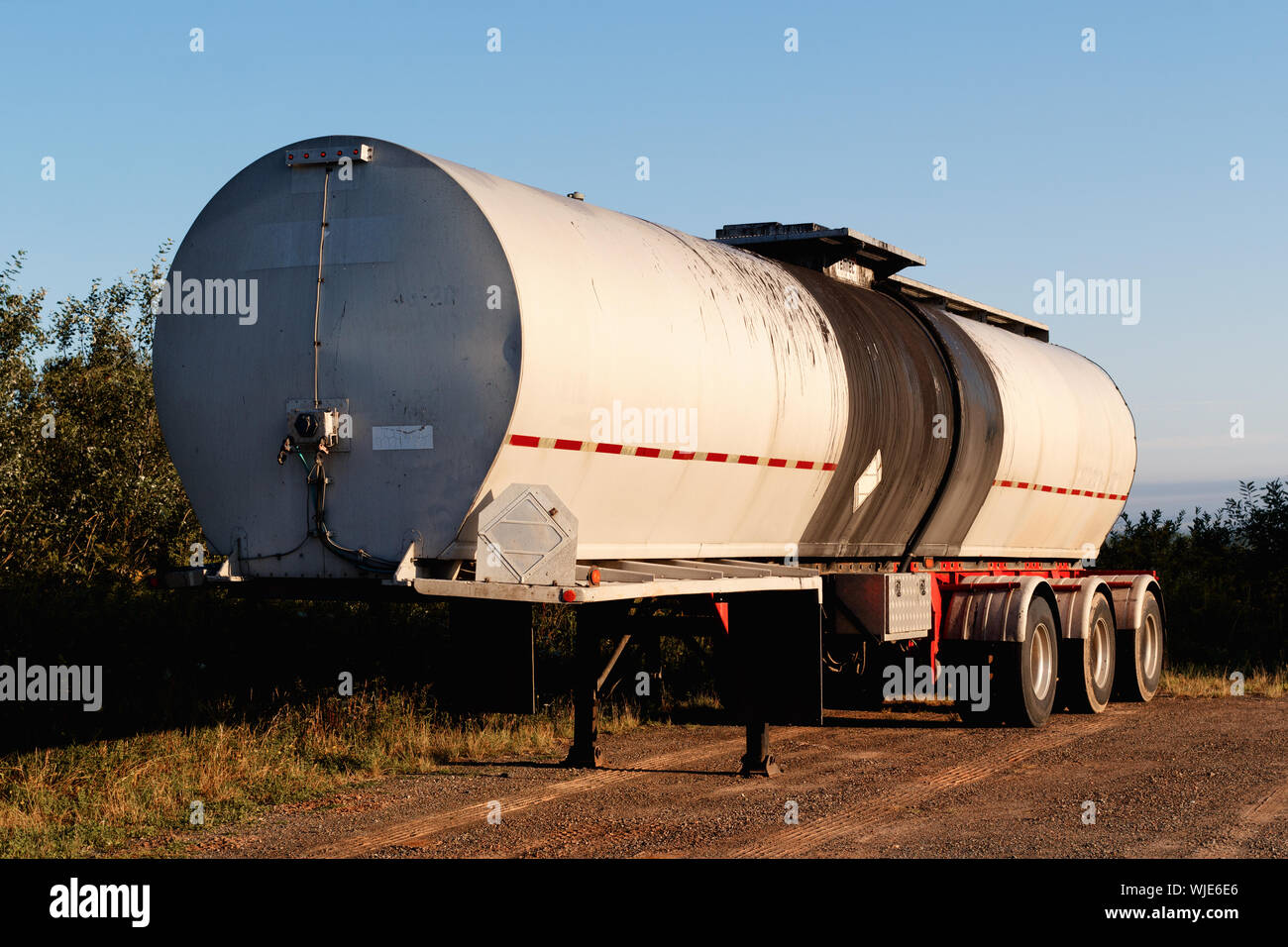 Parked semi-truck asphalt tanker trailer with high contrast vintage ...