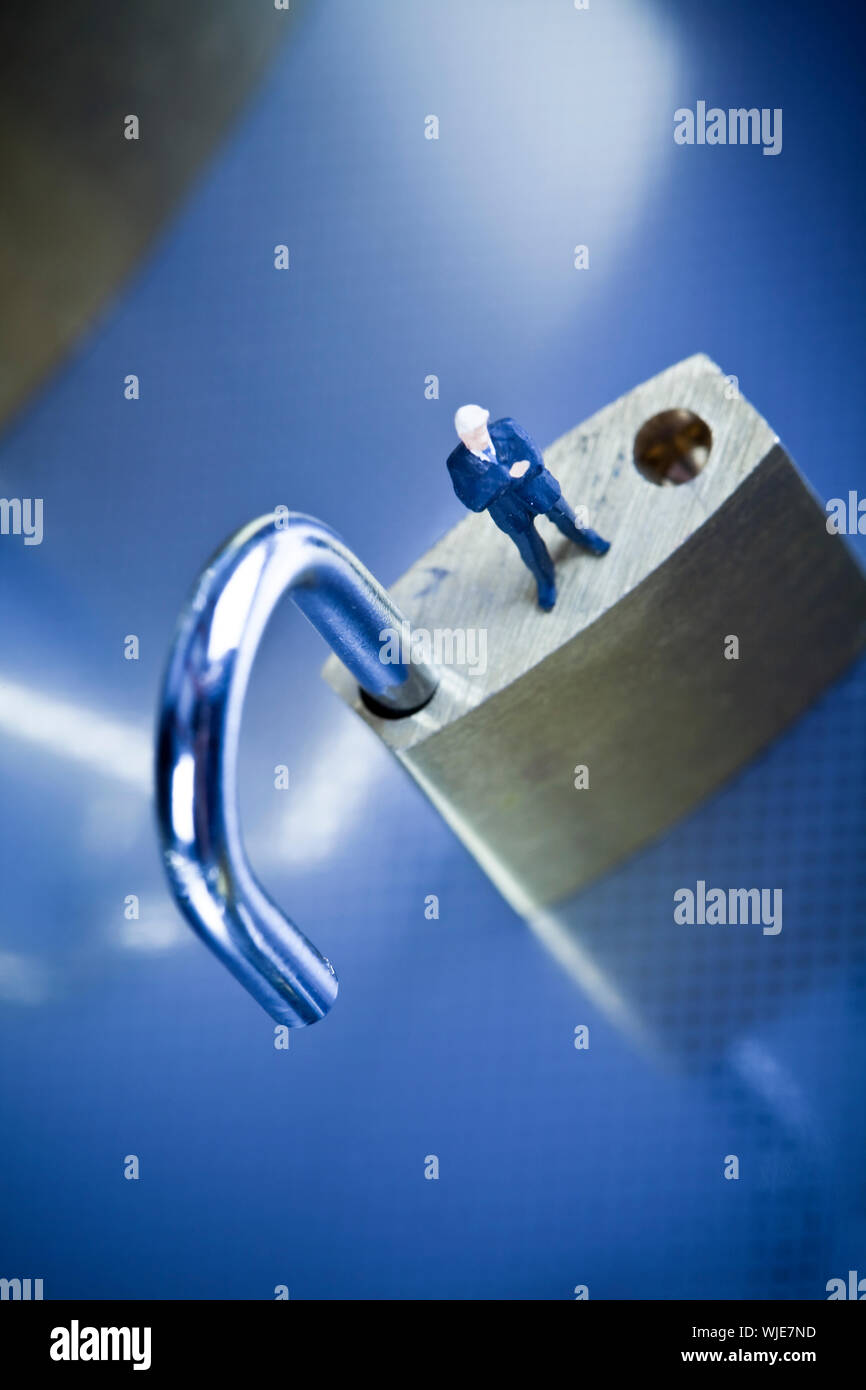 Business man on secure pedlock Stock Photo - Alamy