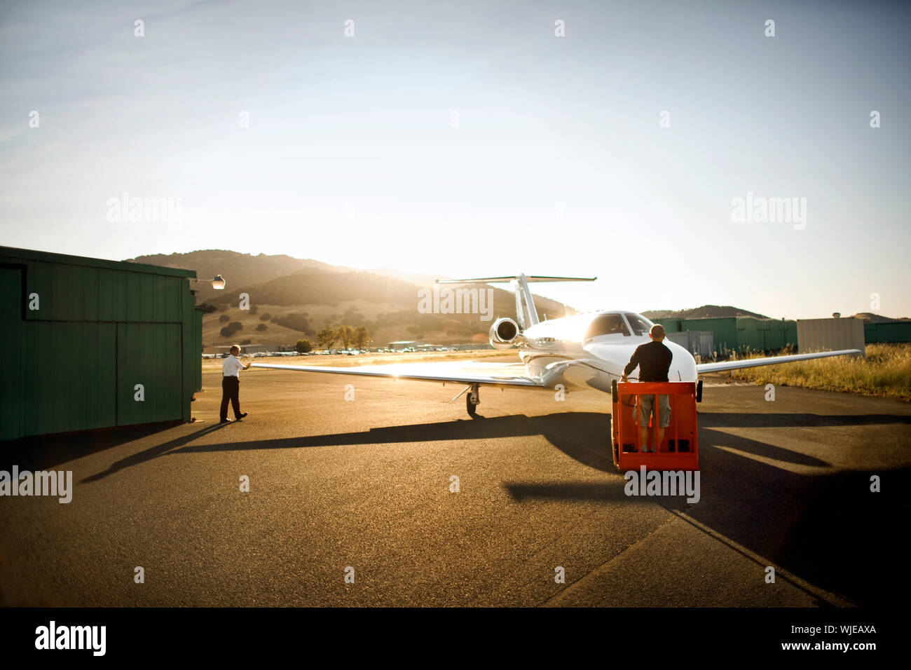 Workers inspecting an airplane Stock Photo - Alamy