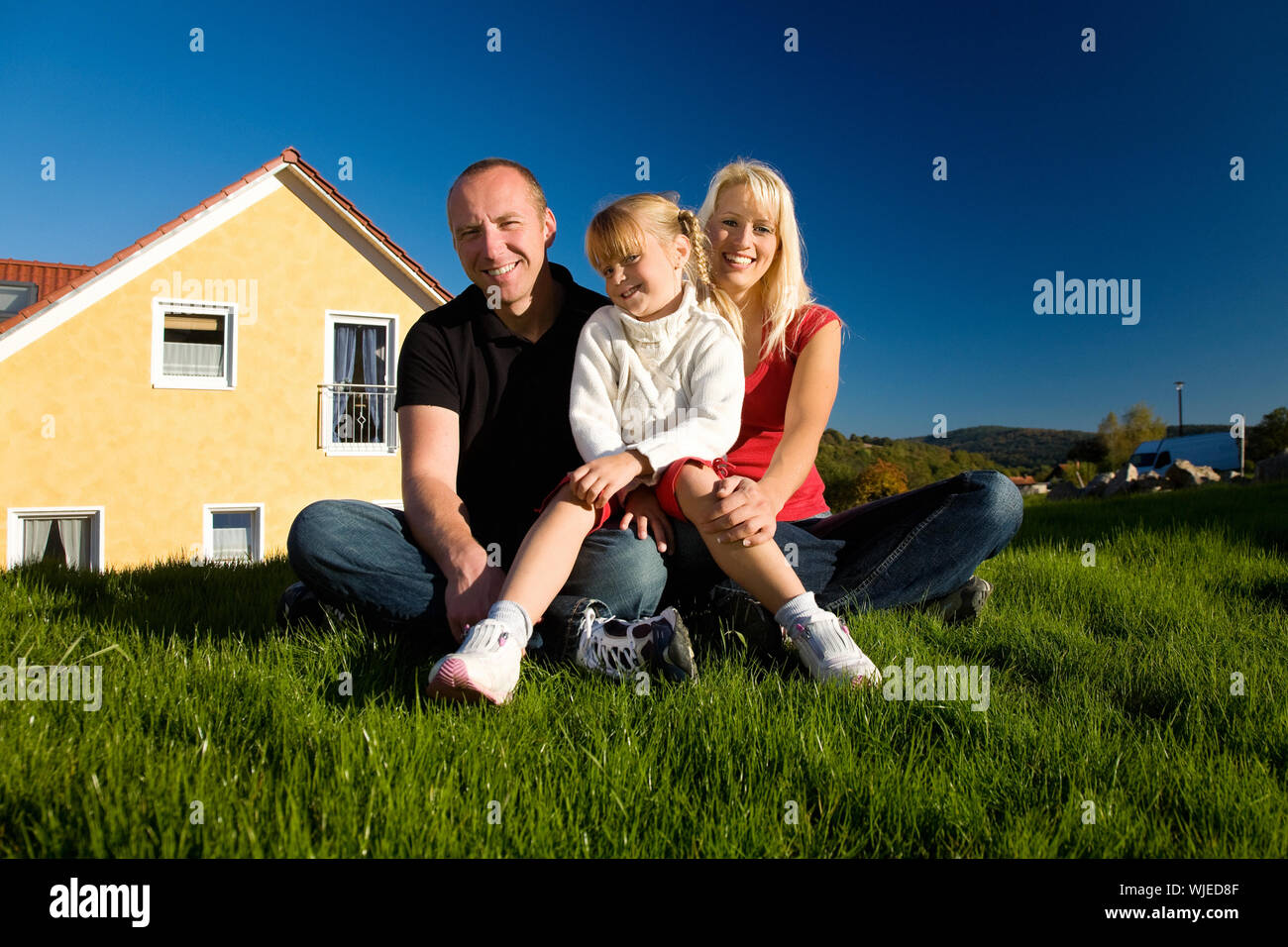 Family and their home Stock Photo - Alamy