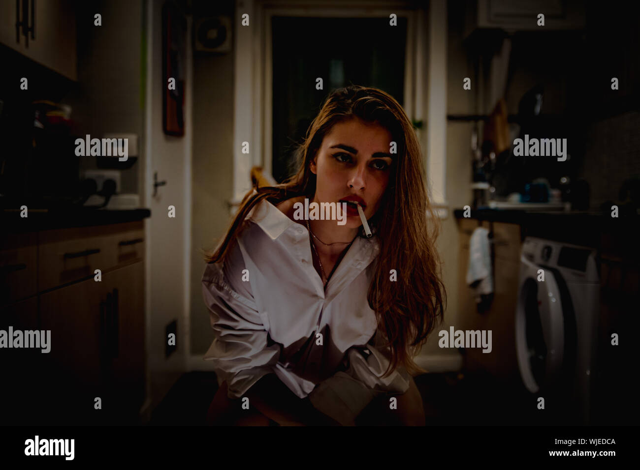 Woman Smoking In Kitchen High Resolution Stock Photography and Images ...