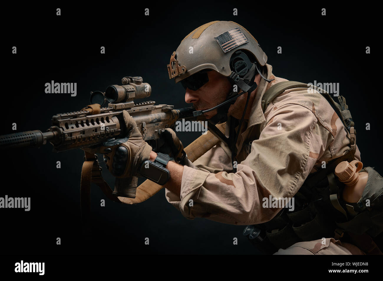 Safety helmet holding rifle army soldier military hi-res stock ...