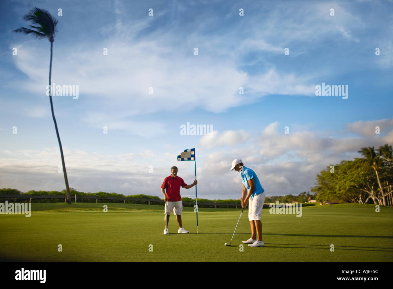 Couple playing golf together Stock Photo - Alamy