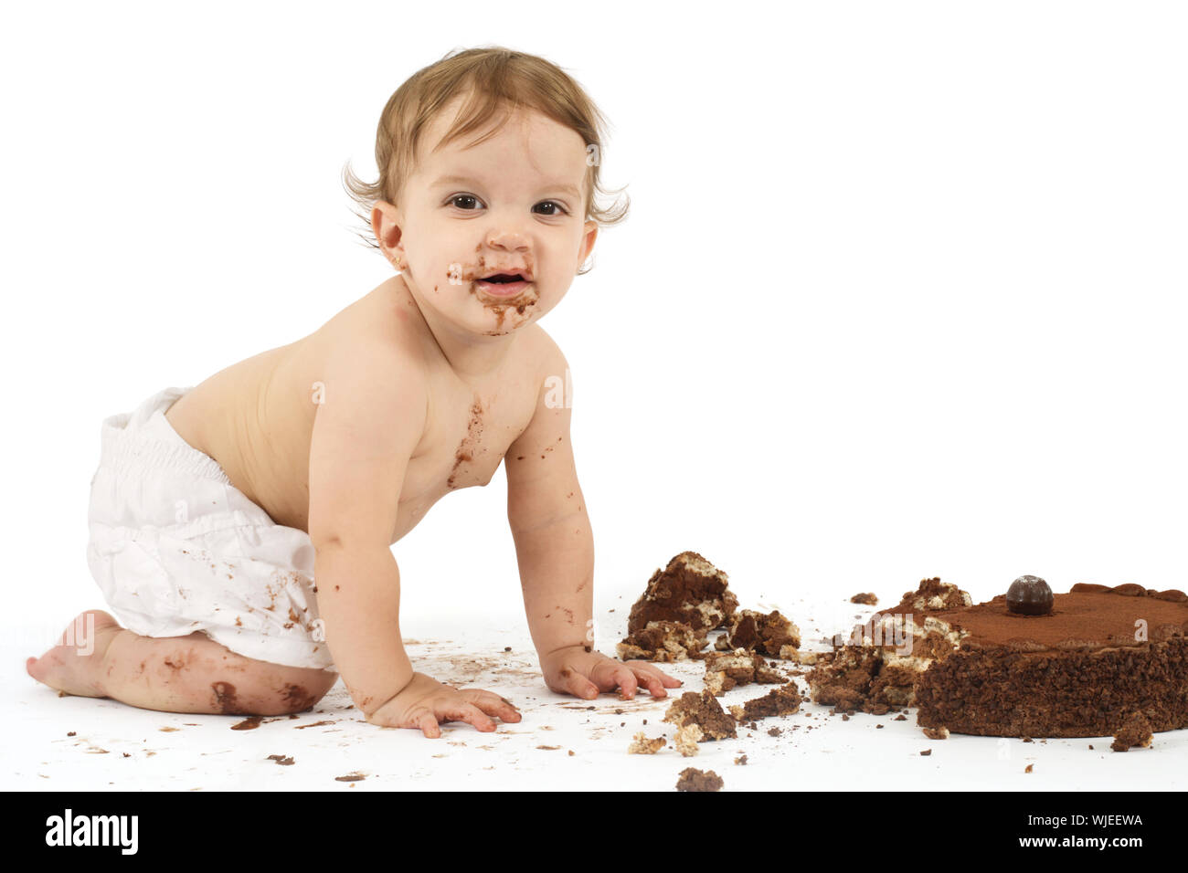An adorable one year old girl enjoying her first birthday cake Stock ...