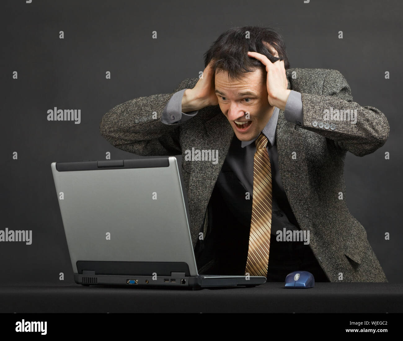 The young man shouts with despair looking at the computer screen Stock ...