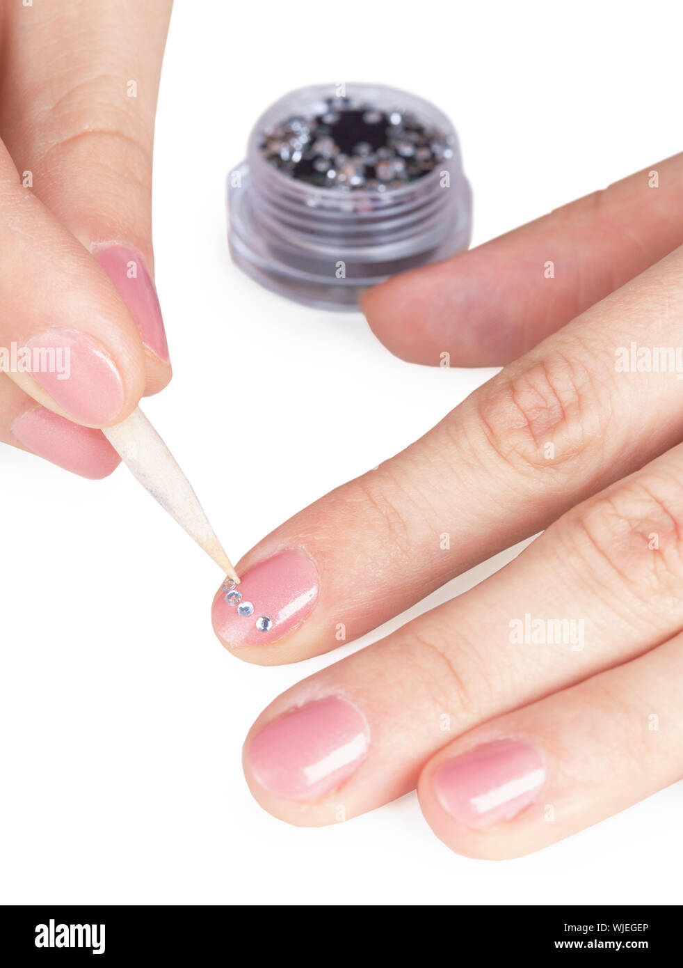 Process of gluing small a paste on a nail close up Stock Photo - Alamy
