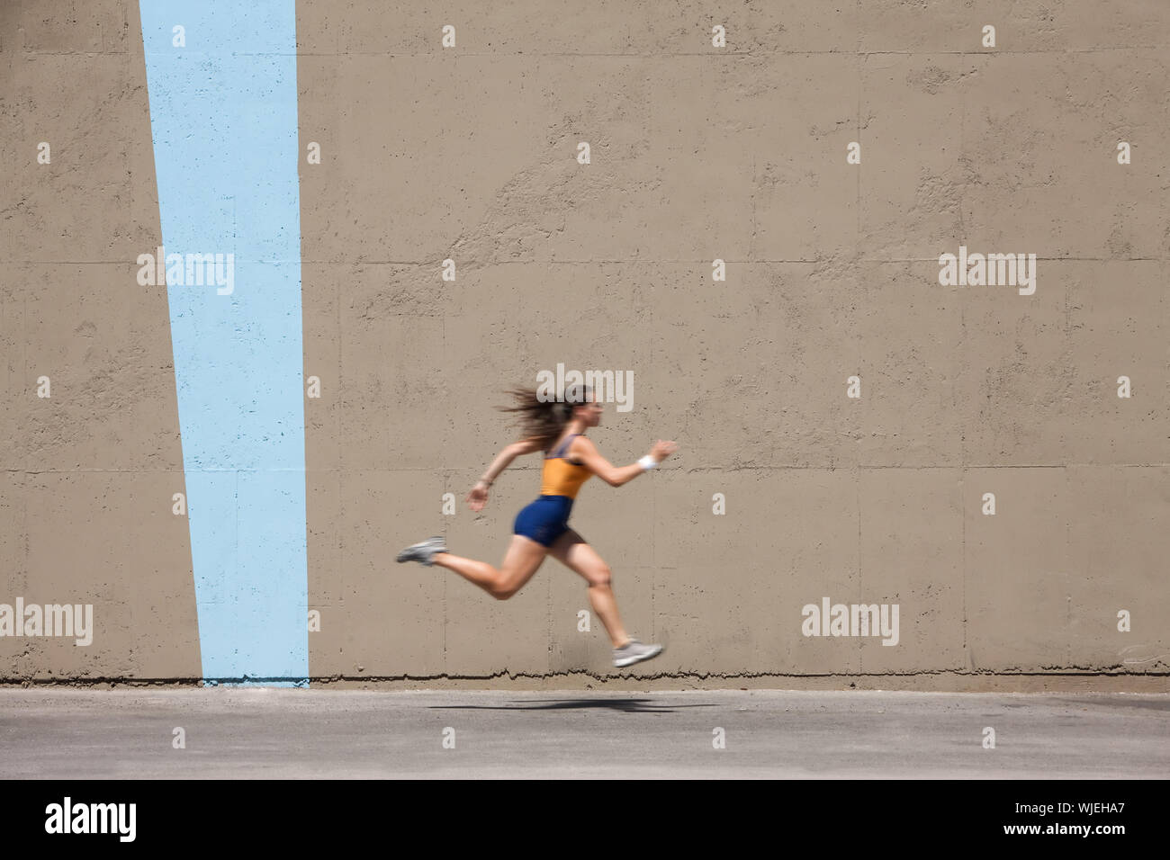 Woman sprinter practices her dash to the finish line Stock Photo - Alamy