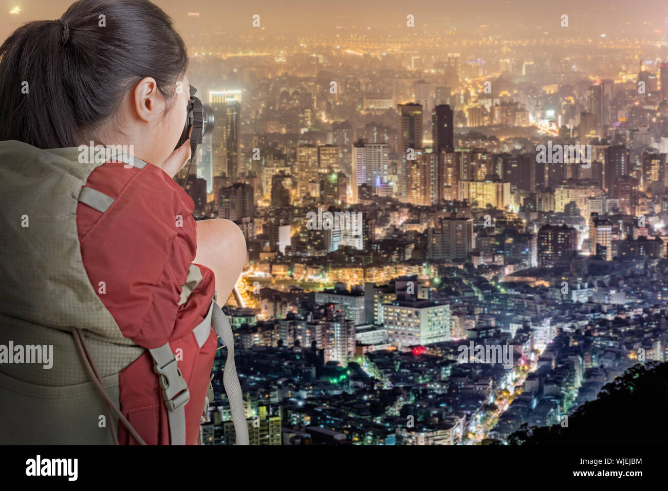 Young backpacker travel and take picture of city night scene in Taipei ...
