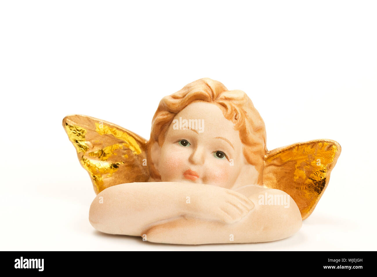 one christmas angel figurine with crossed arms on white background ...