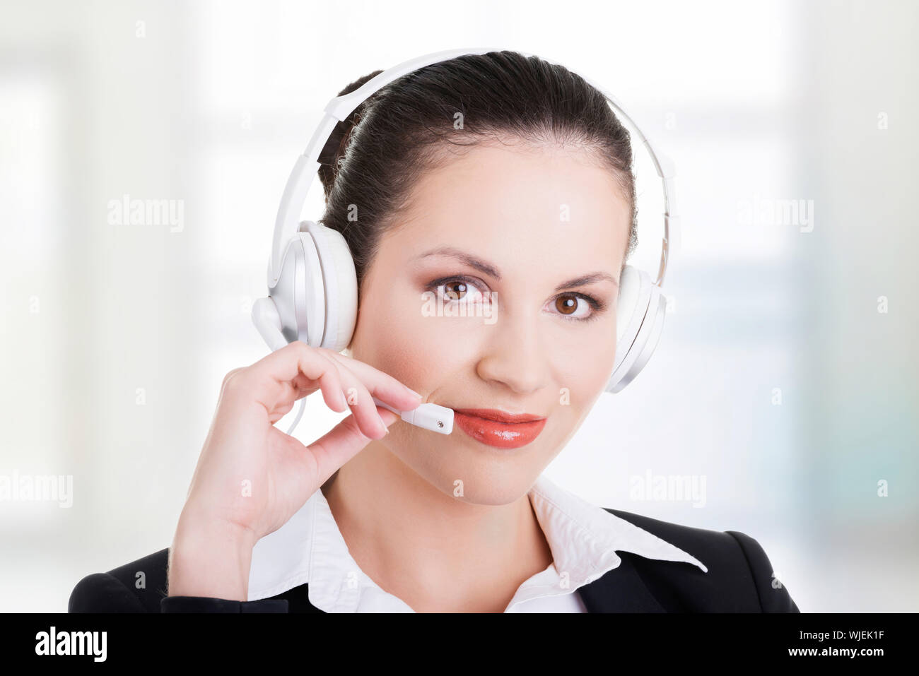 Beautiful young call-center assistant at the desk, isolated on white ...
