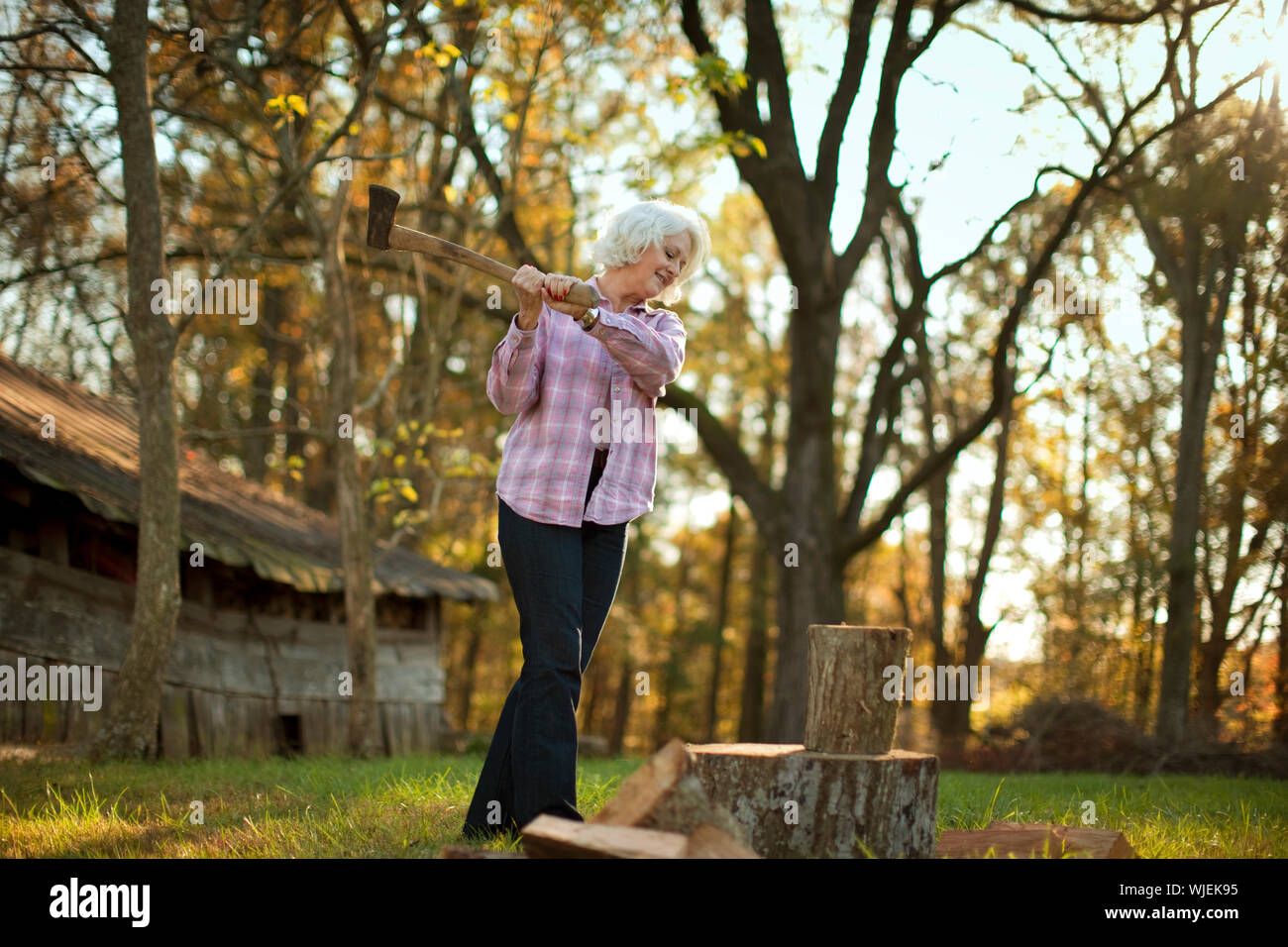 Woman chopping wood outdoors hi-res stock photography and images - Alamy