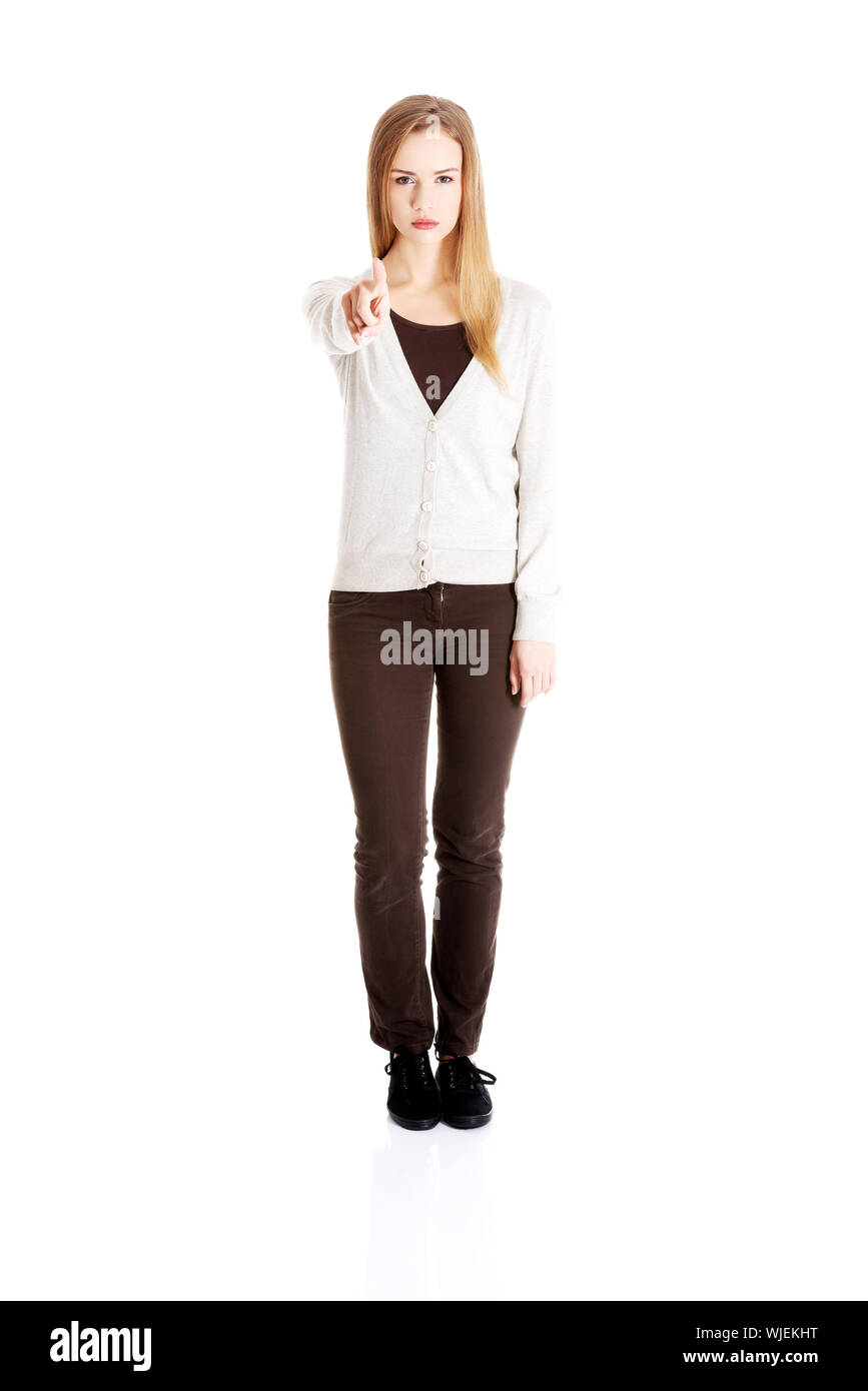 Beautiful casual woman pointing on you and warning or accusing of sth ...