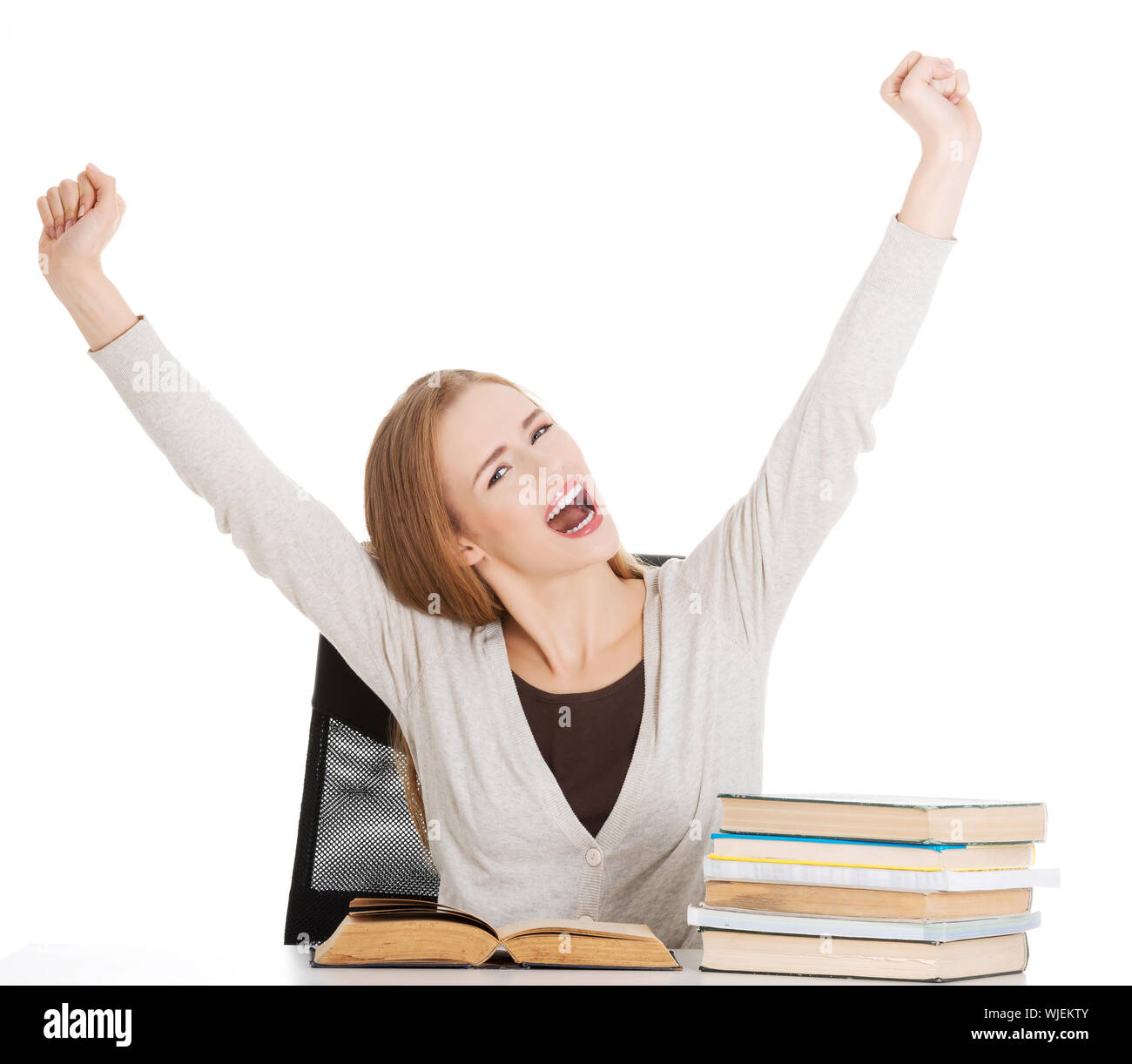 Happy student woman with her hands up and stack of books. Isolated on ...