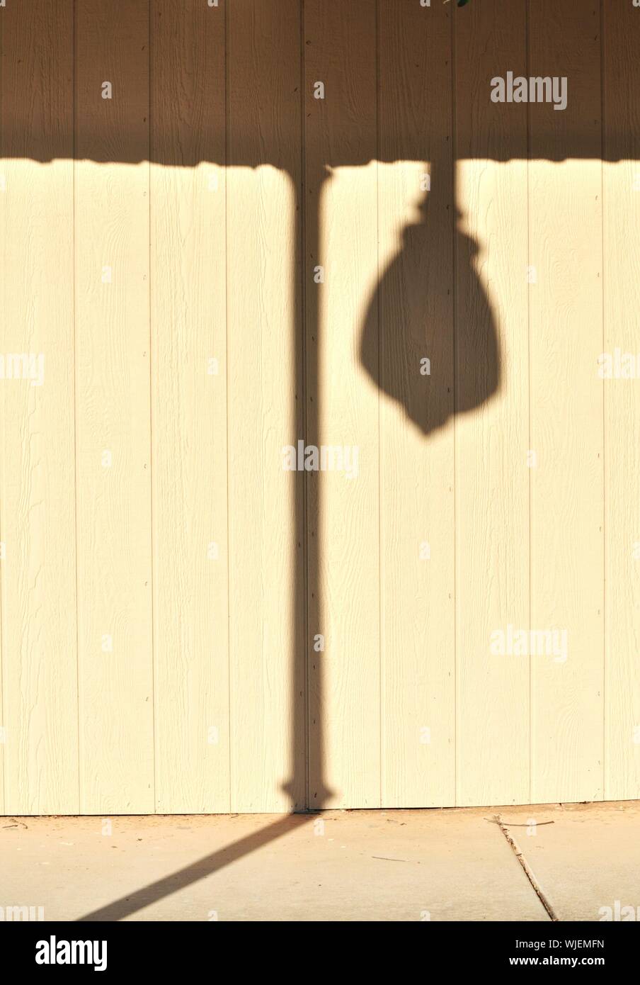 Shadow Of Lamp Post On Beige Wooden Wall Stock Photo - Alamy