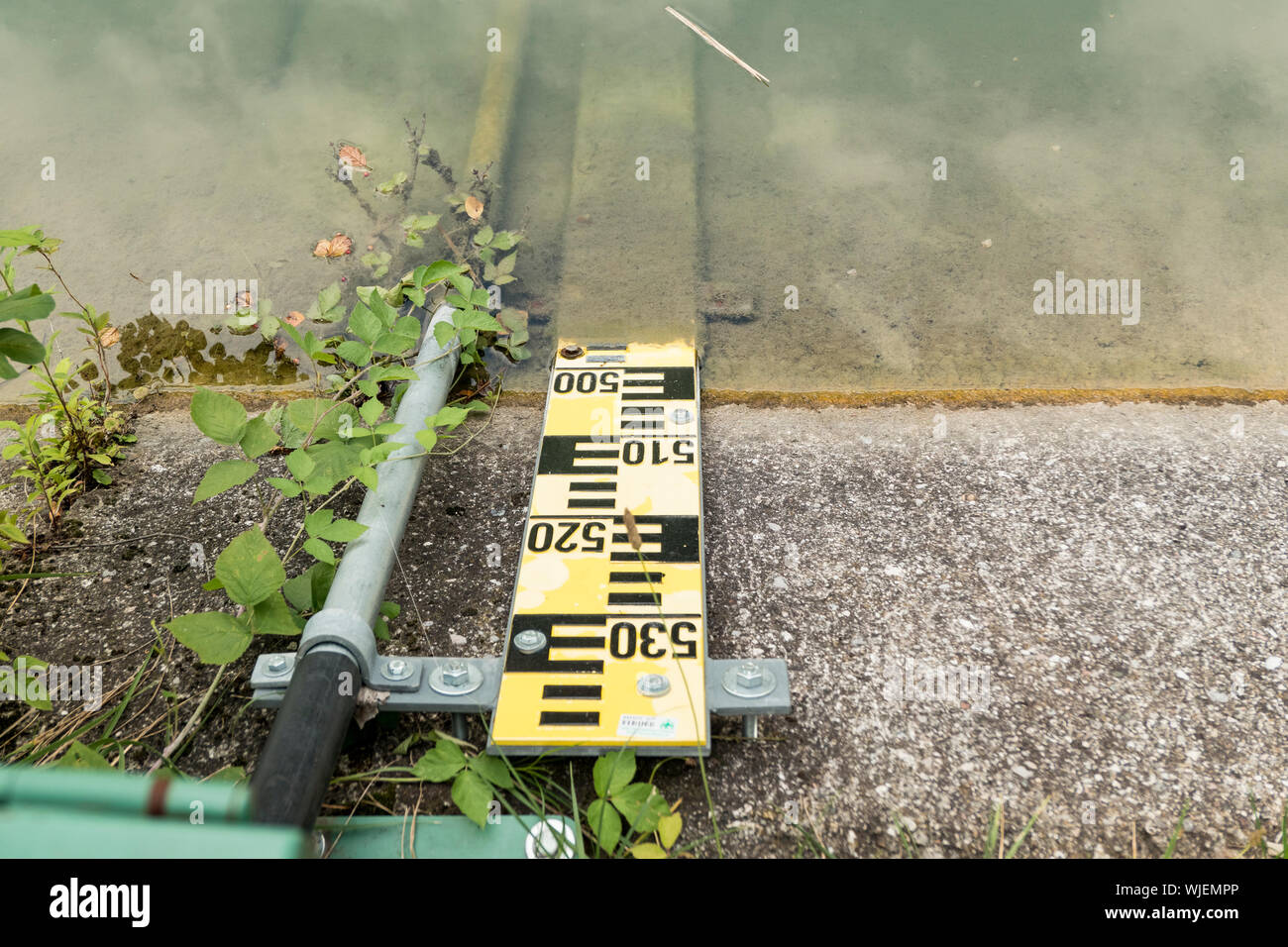 Flood measuring rod in the water to measure the water level Stock Photo ...