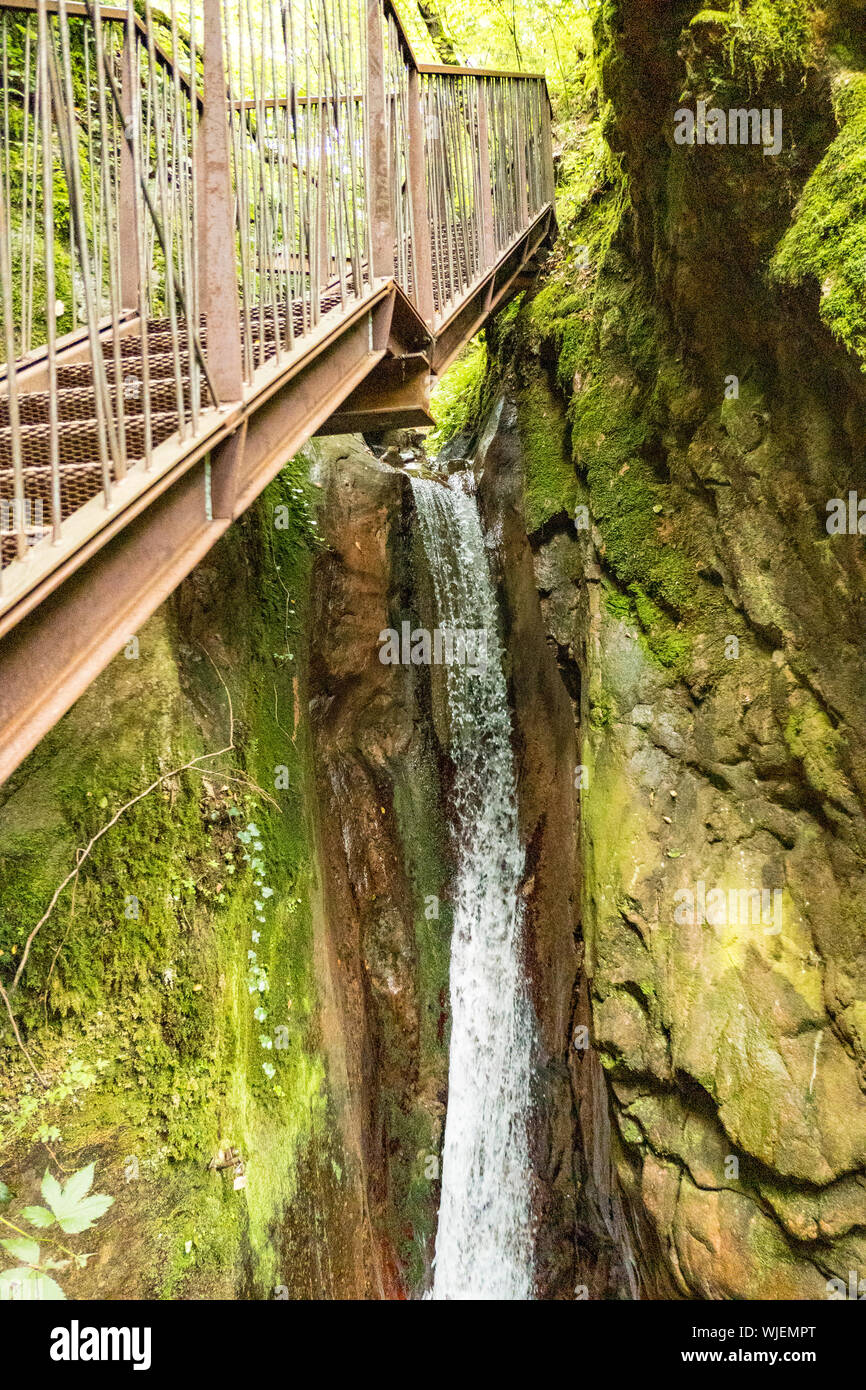 iron bridge at a hiking trail directly above a waterfall Stock Photo ...